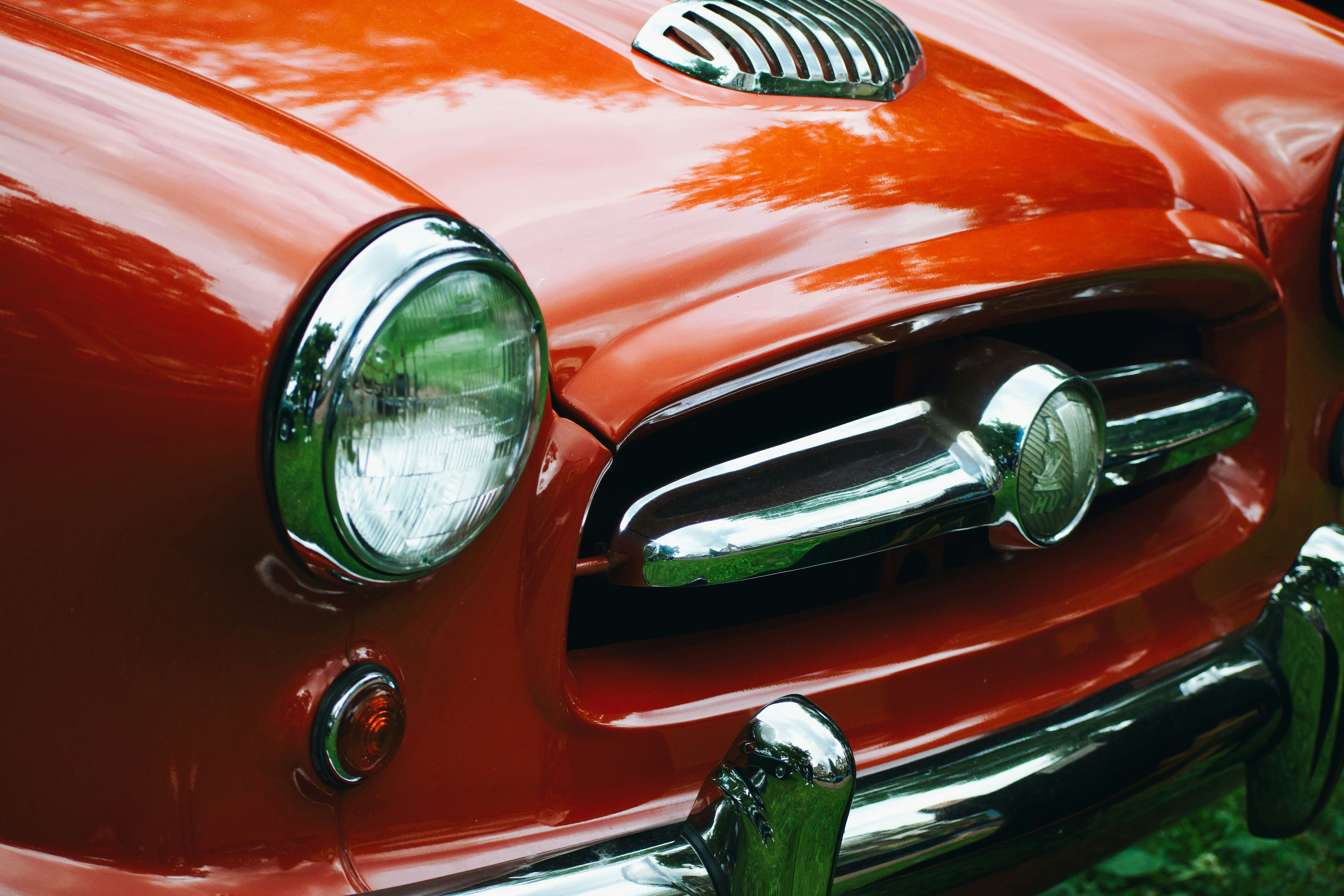 Crimson Classic: Close-up of a Vintage Cruiser's Grinning Grill