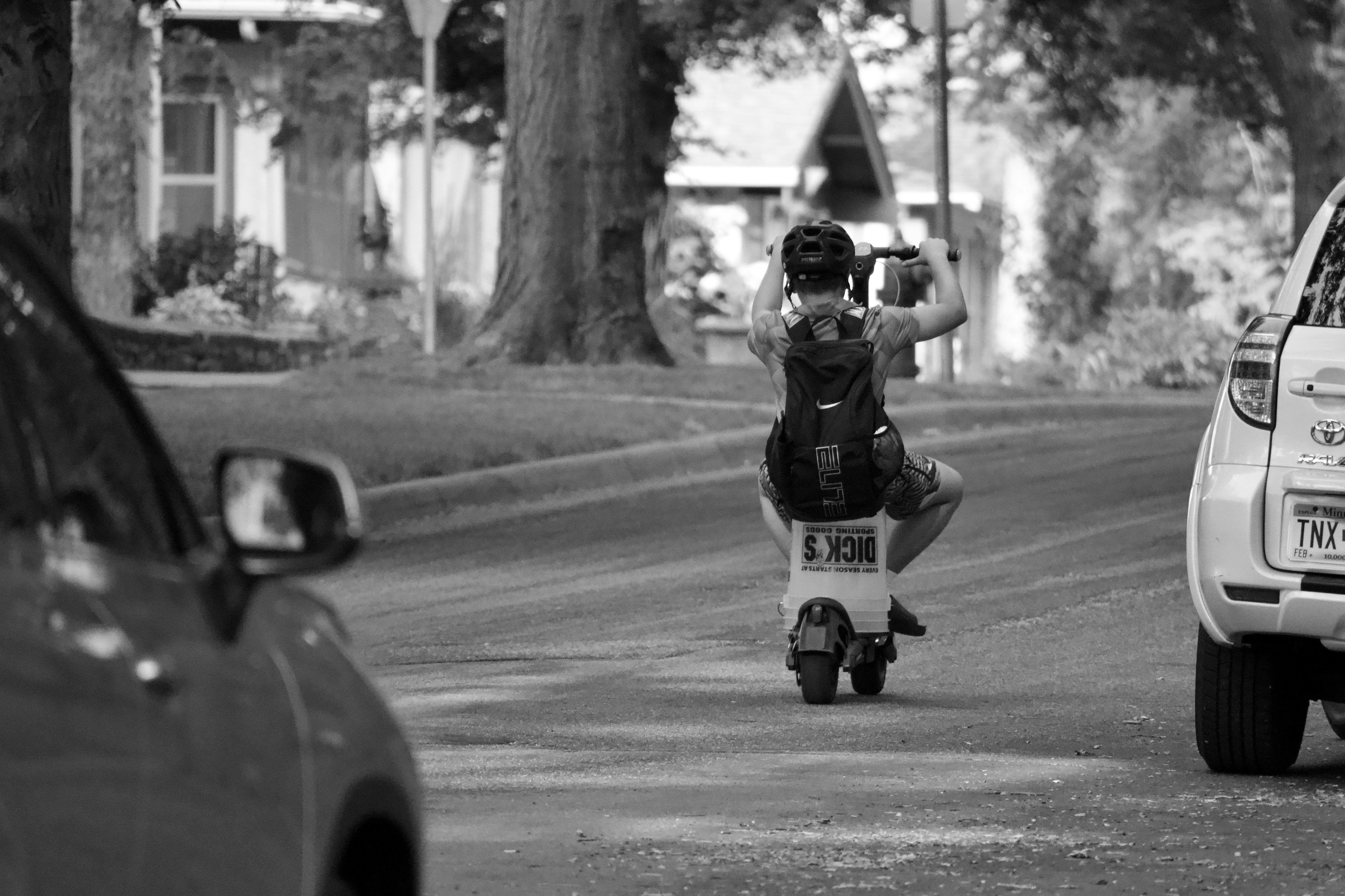 Balancing on Two Wheels: A Street Stunt in Quiet Monochrome