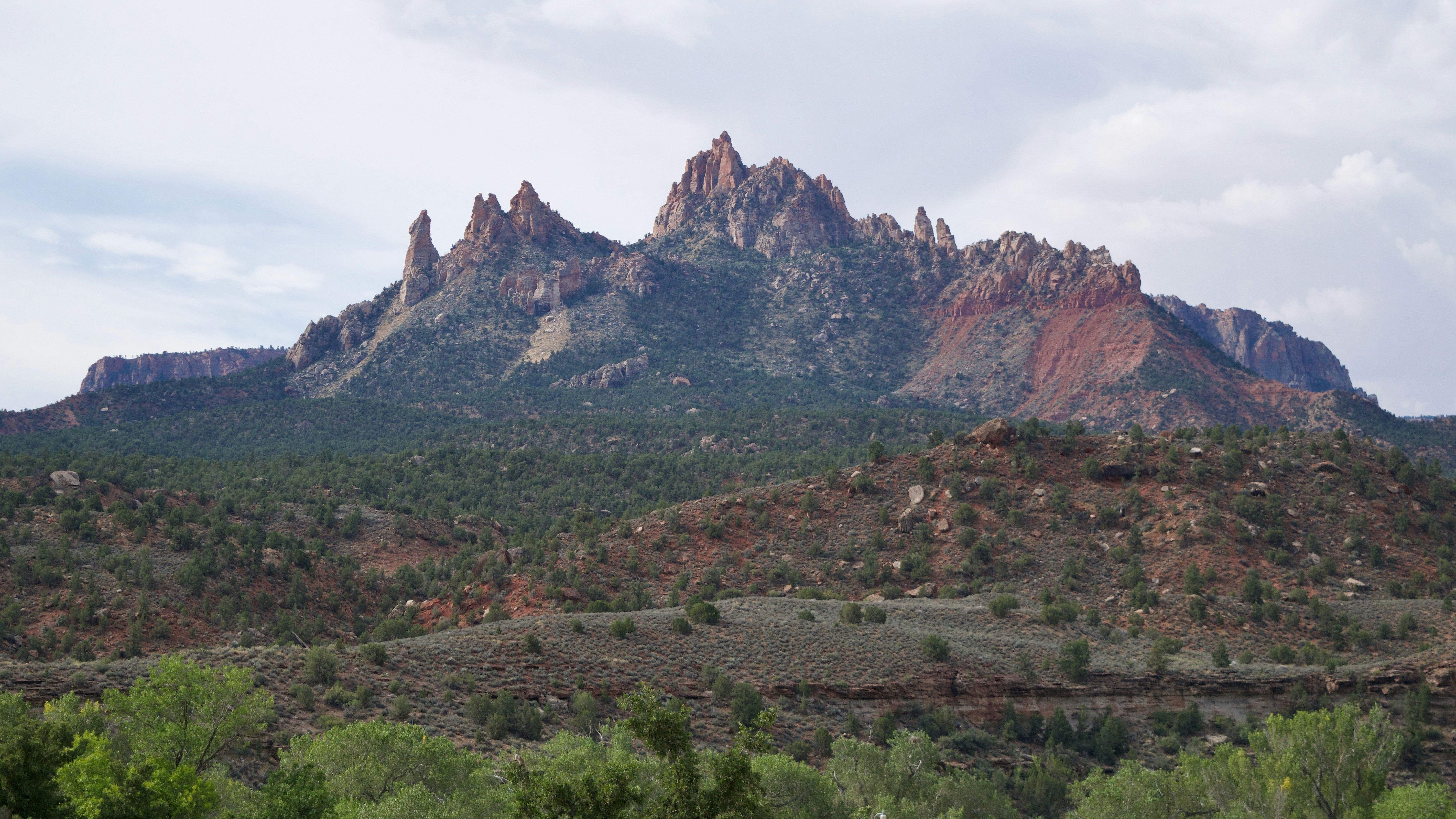 Rugged Summit: A Lone Mountain Crest Reaching into Sky