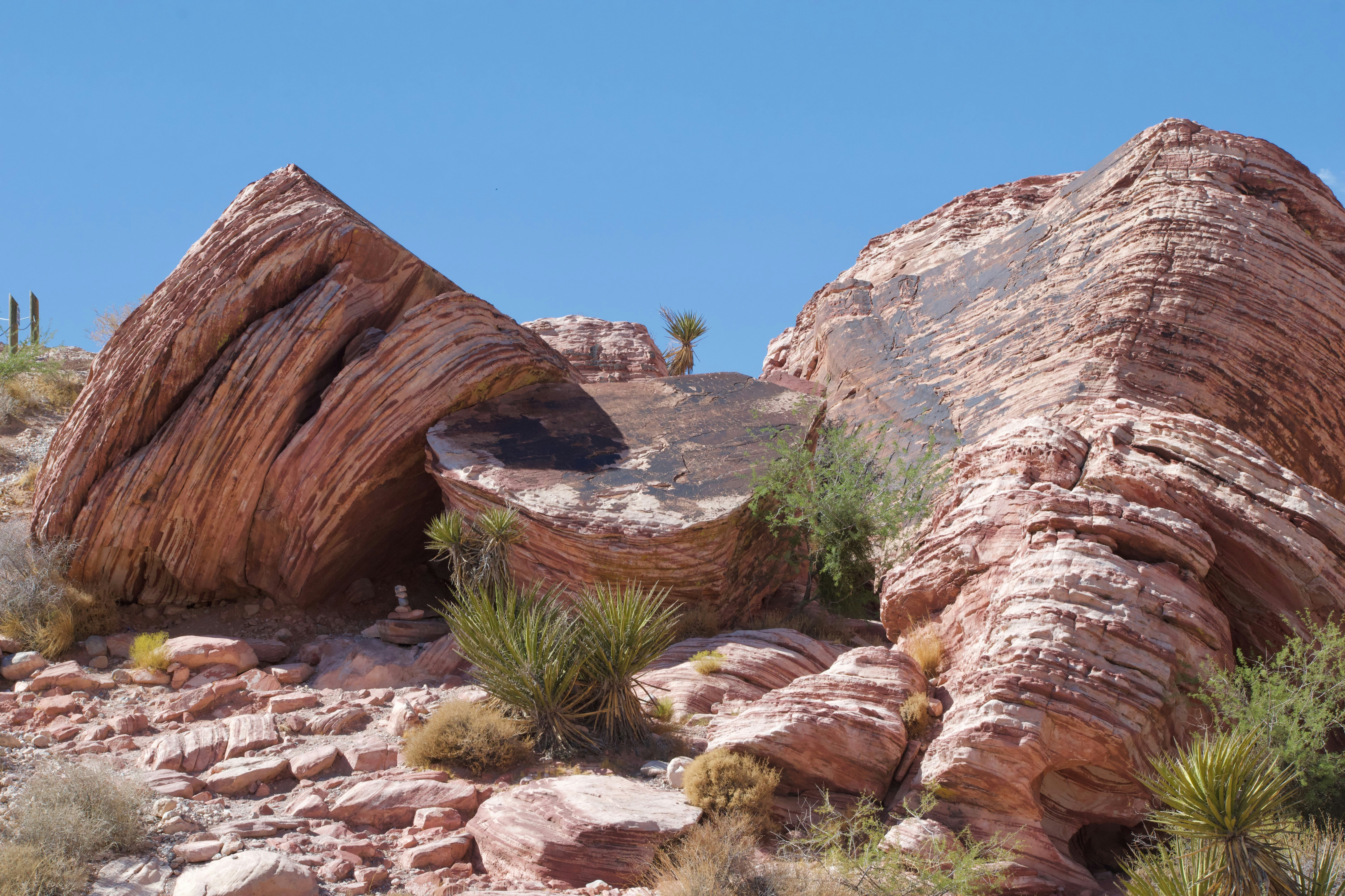 Desert Stonework: Red Sandstone Arches in a Sail-Peaked Landscape