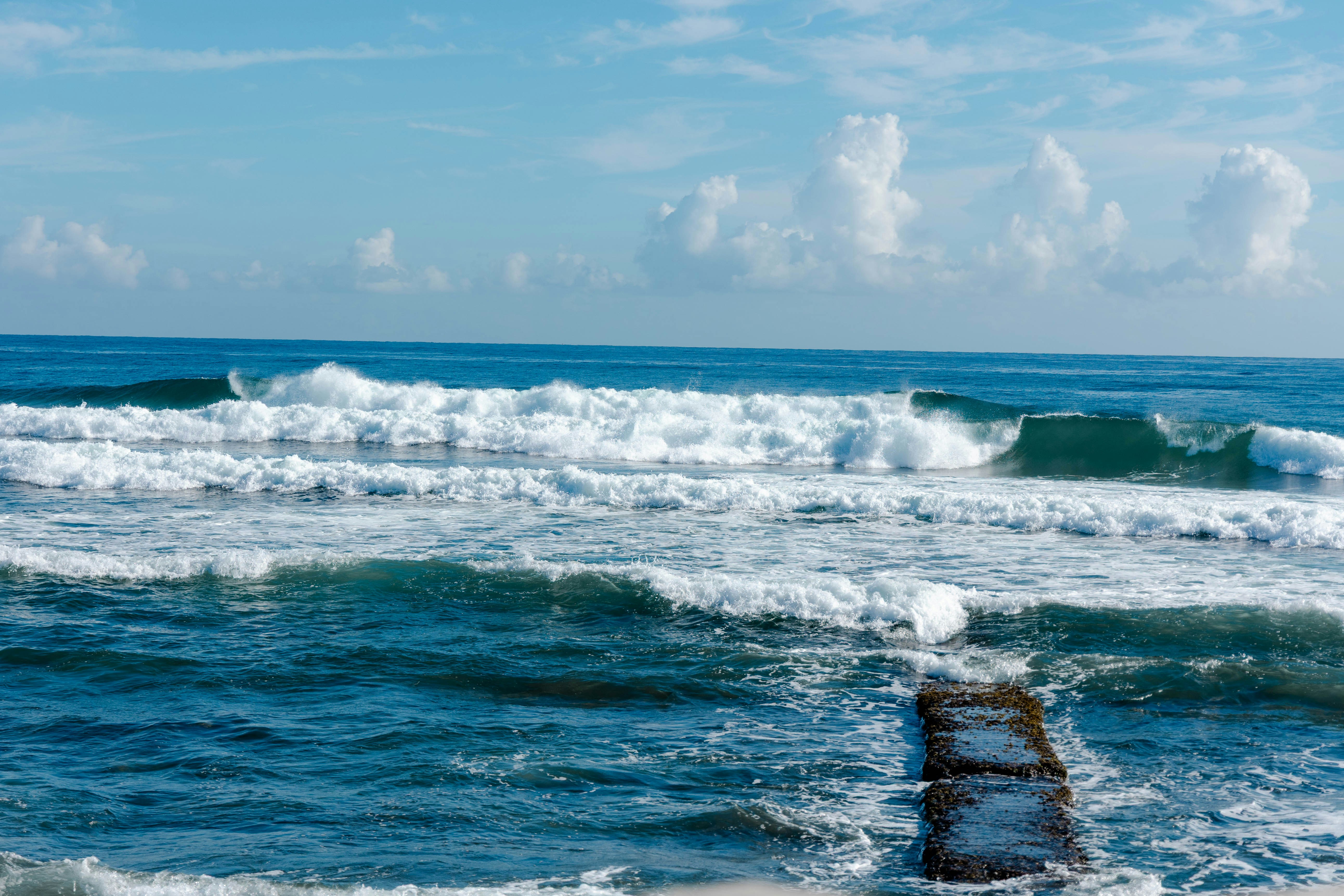 Line of Breakers: A Calm Pier Reaches into the Sea