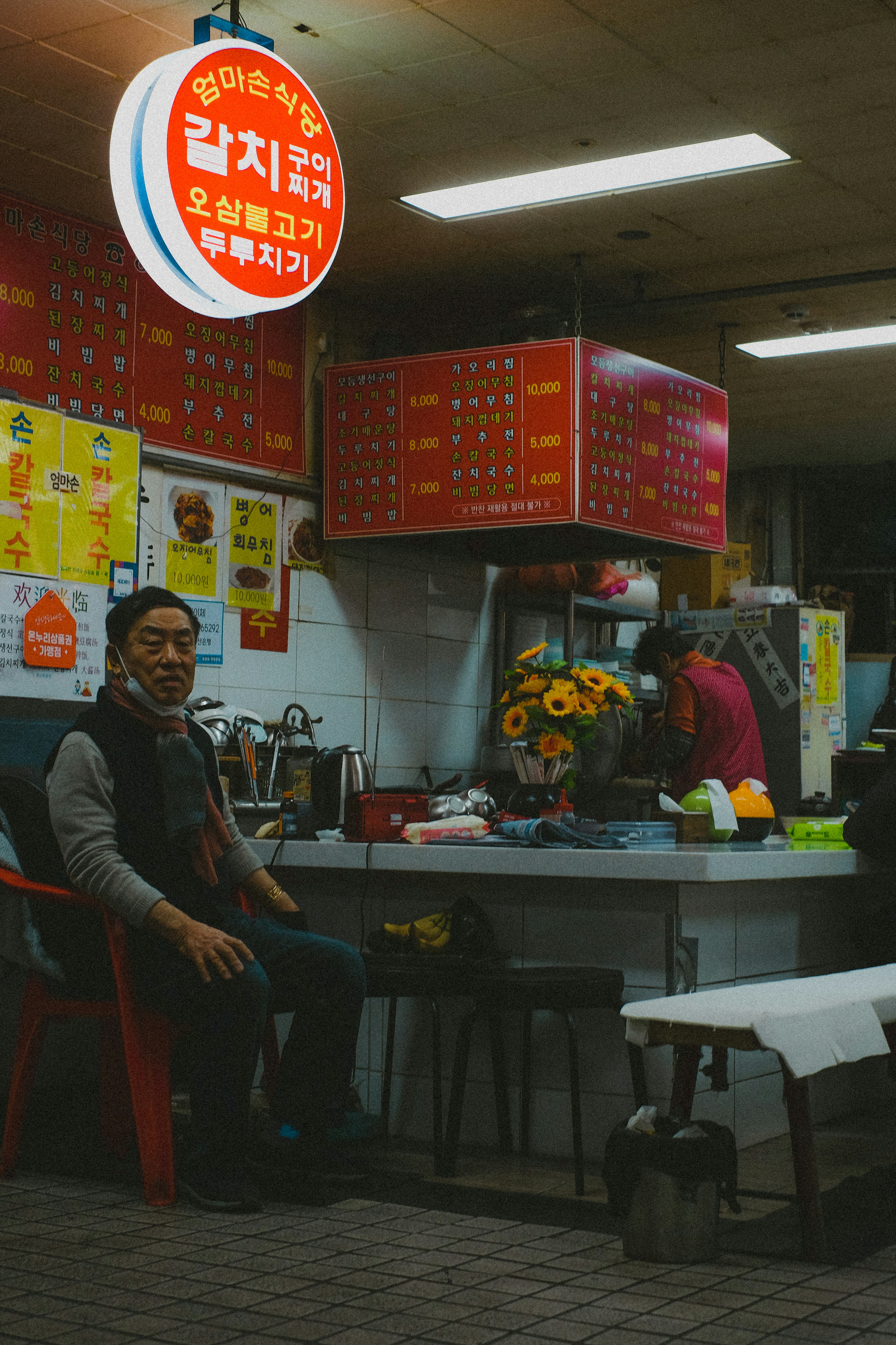Night Market Portrait: A Quiet Moment Behind the Counter