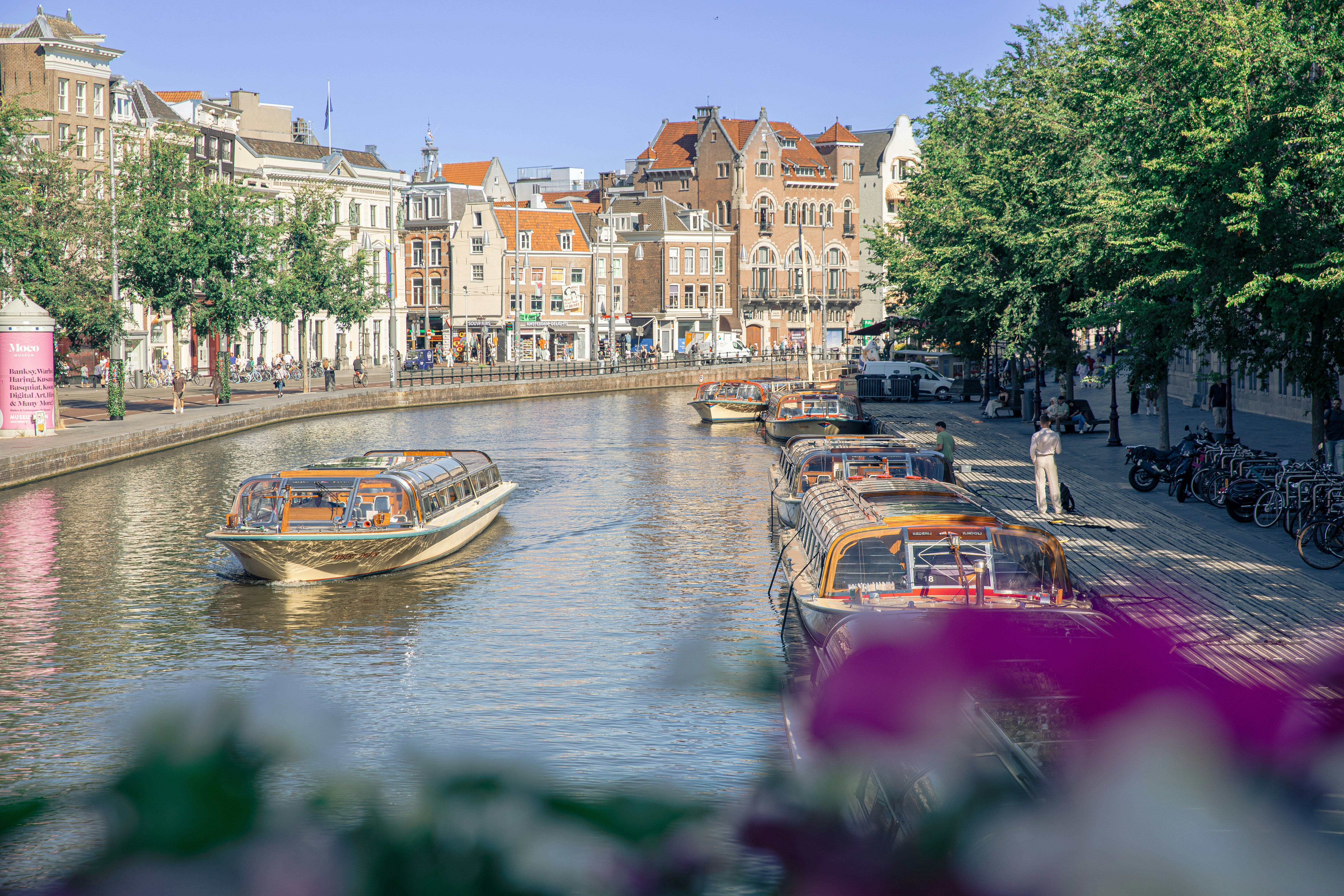 Canal Life in Bloom: Boats, Brick Facades, and River Light