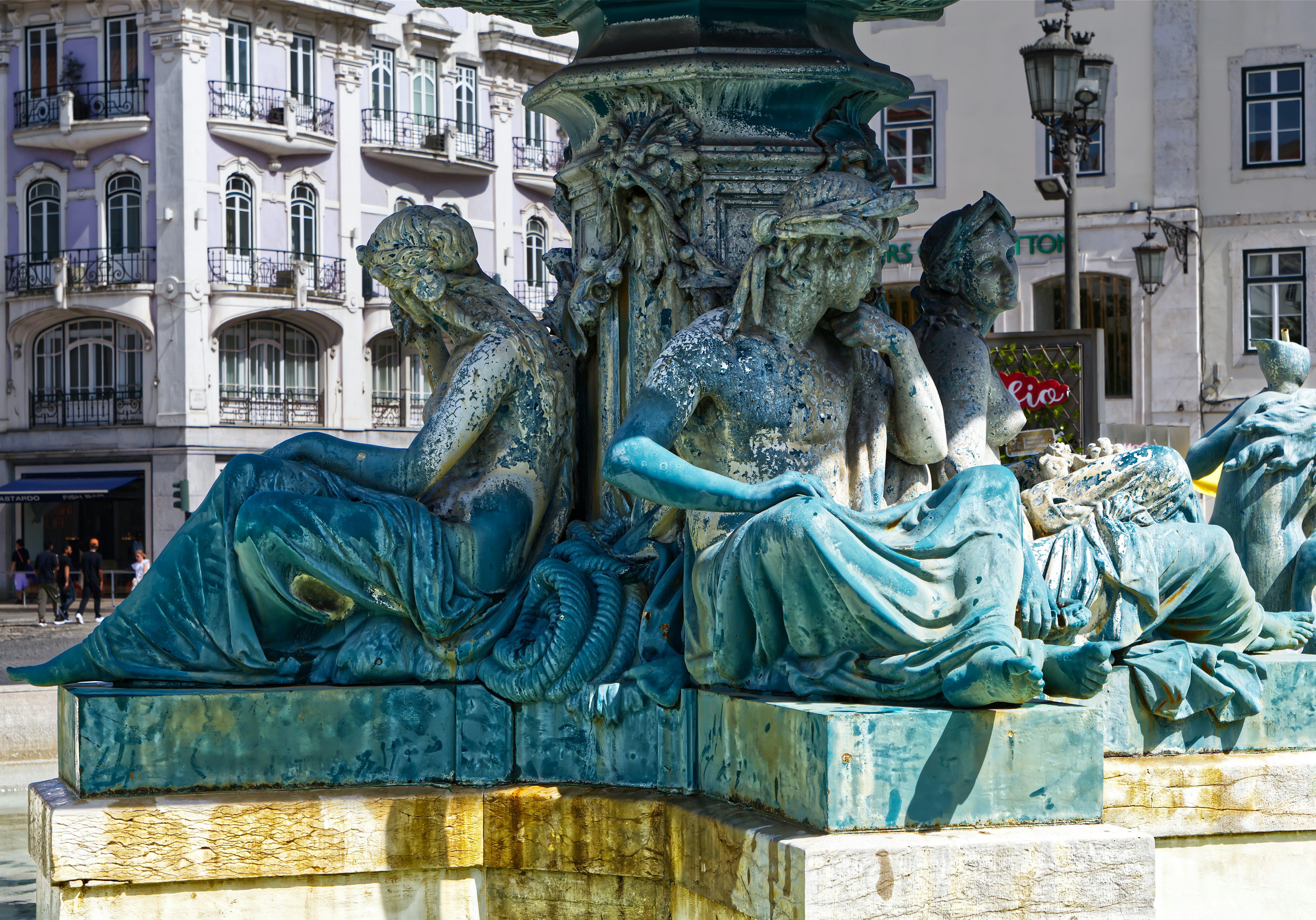 Weathered fountain of reclining figures under a European square