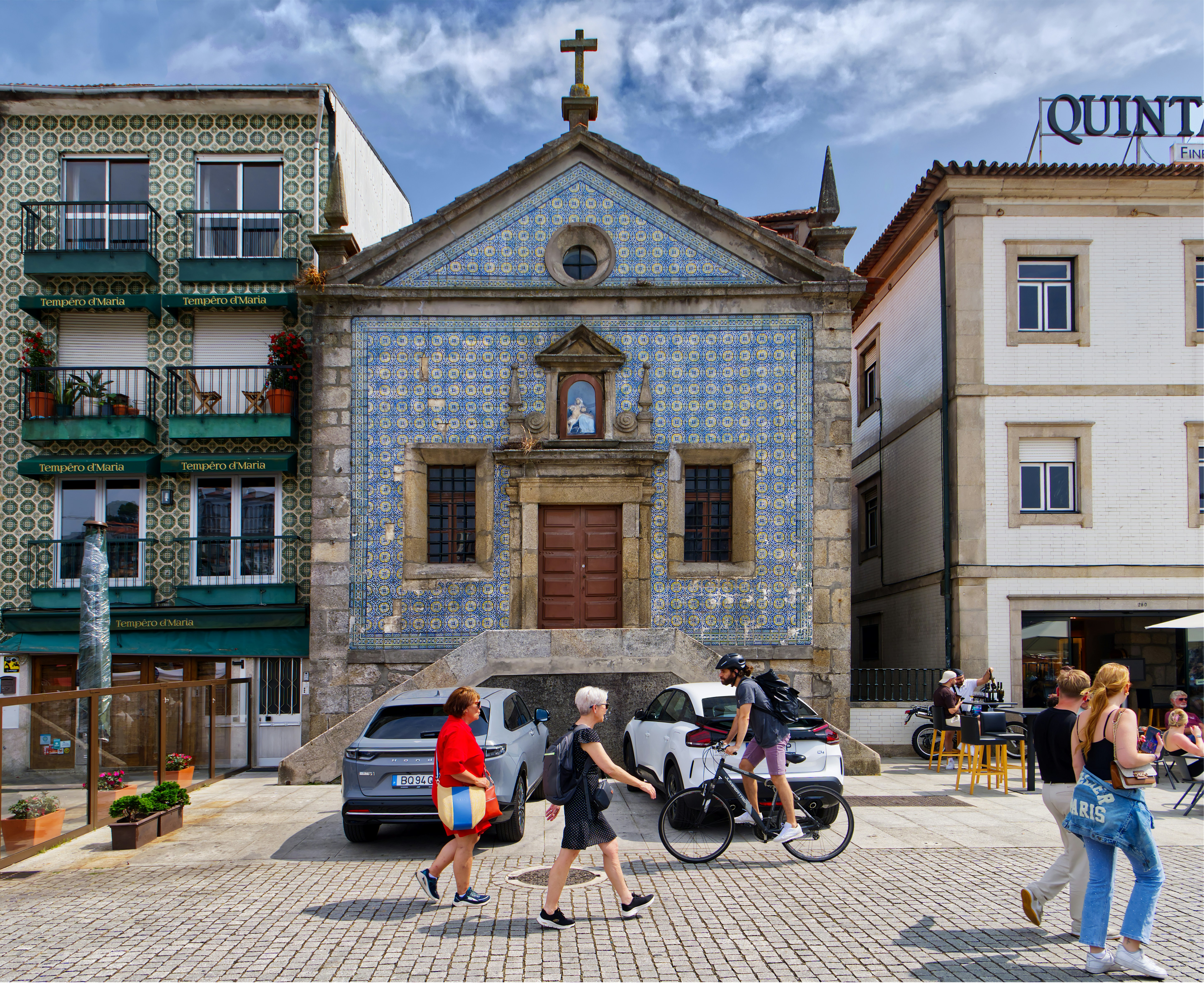 Blue Tile Facade and Pedestrian Pulse by the Church
