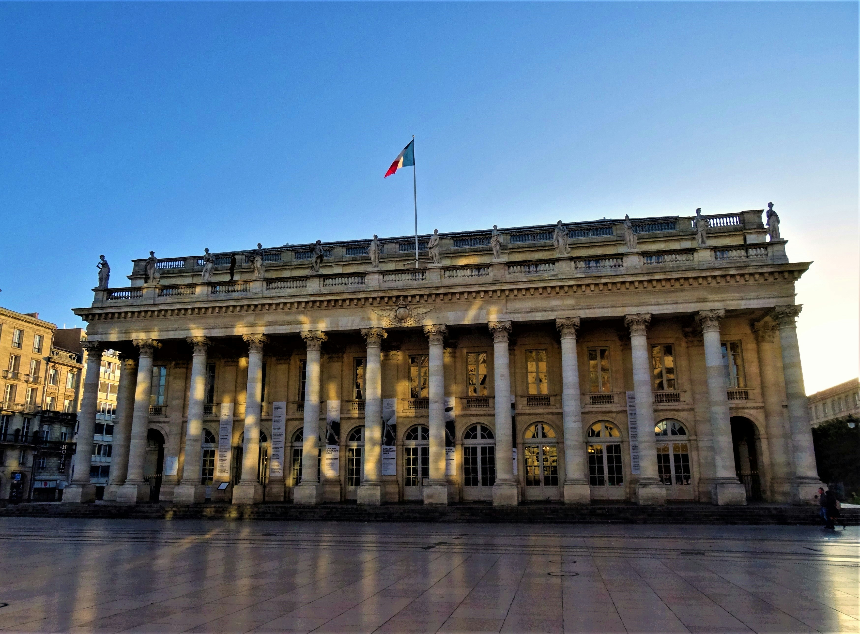 Grand Facade in Morning Light: Columns Standing Guard Over the Square