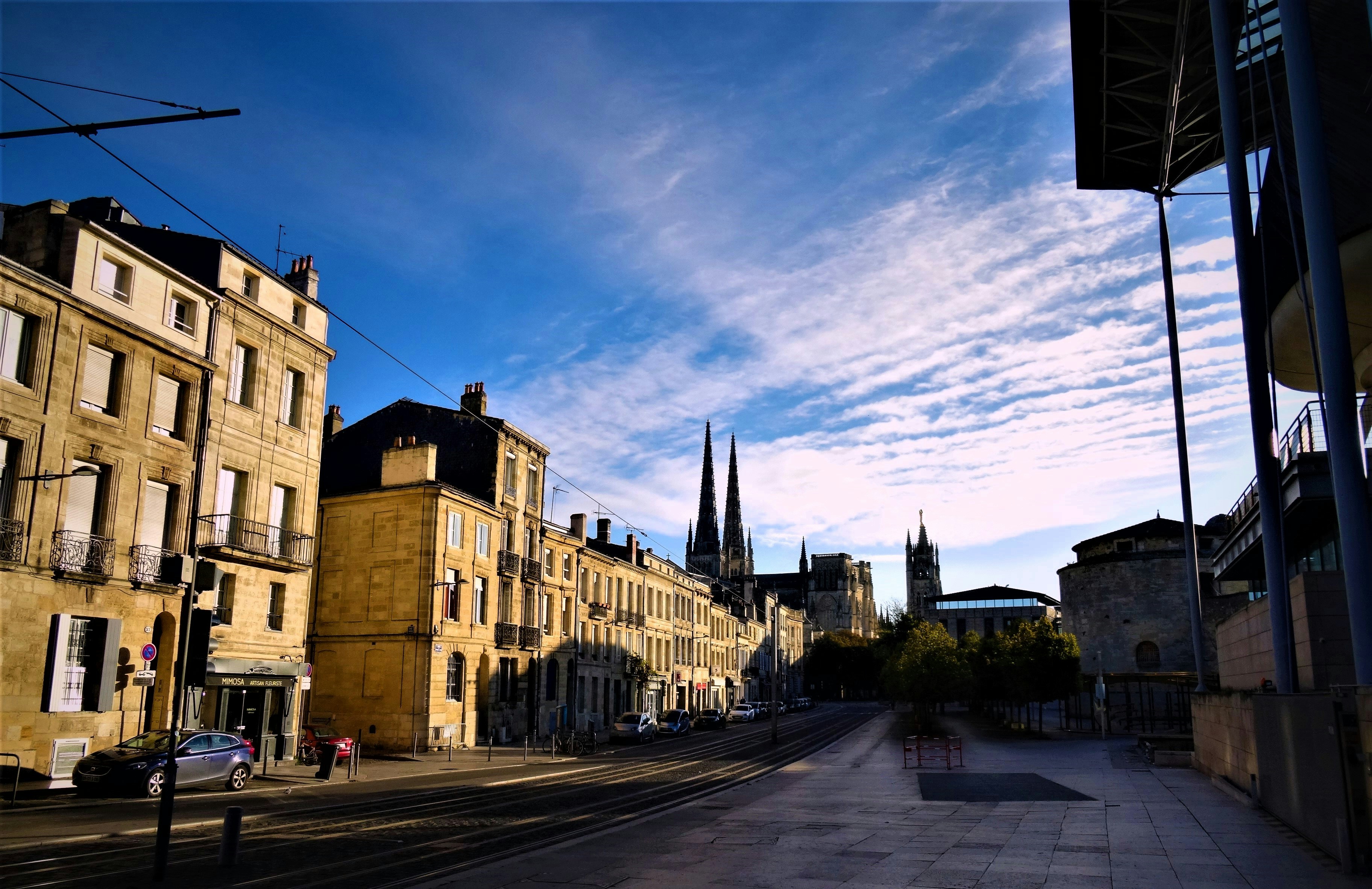 Cathedral Silhouette Over a Sunlit Riverside Street