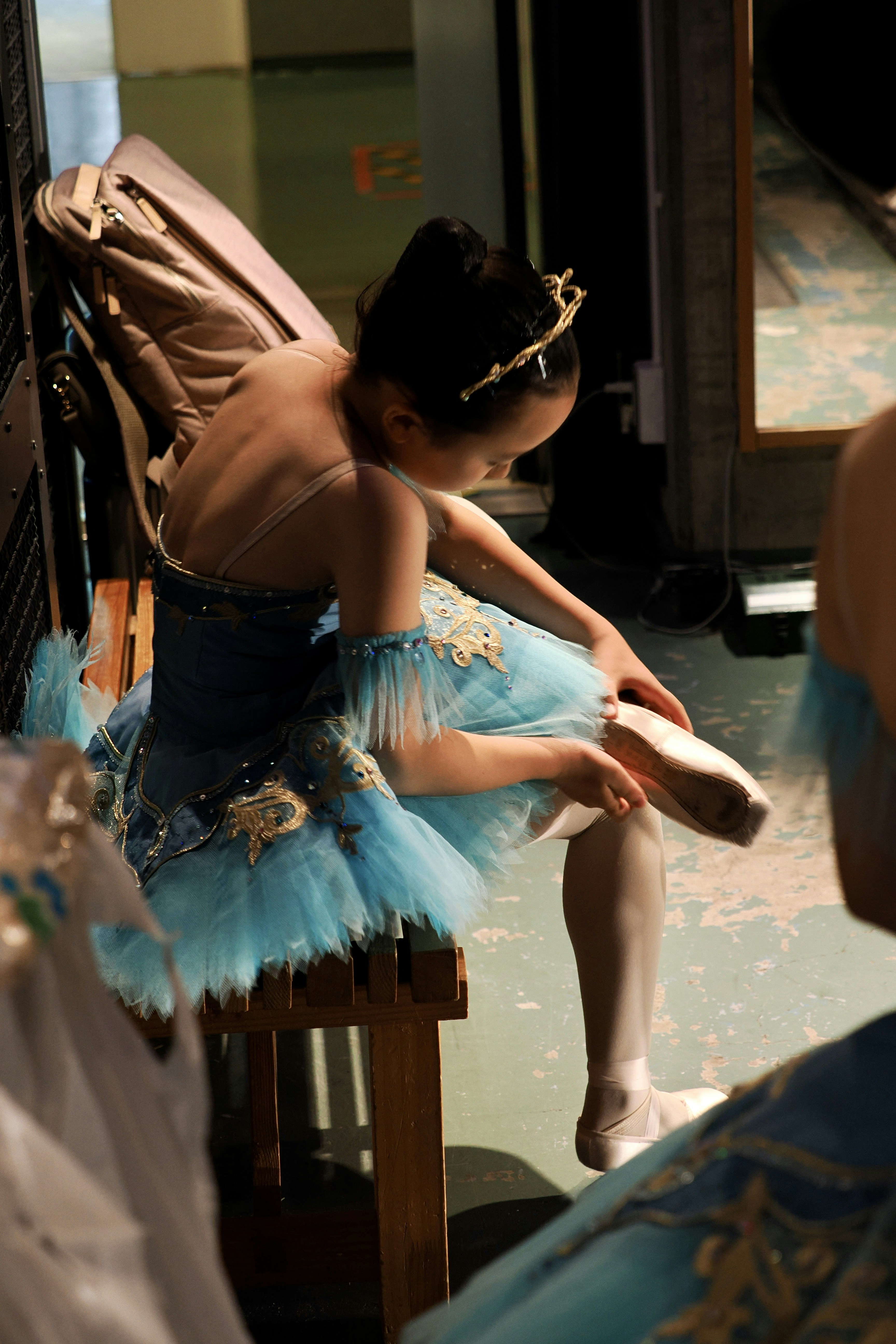 Blue-tutu Ballet Moment: Quiet Preparation in a Backstage Corner