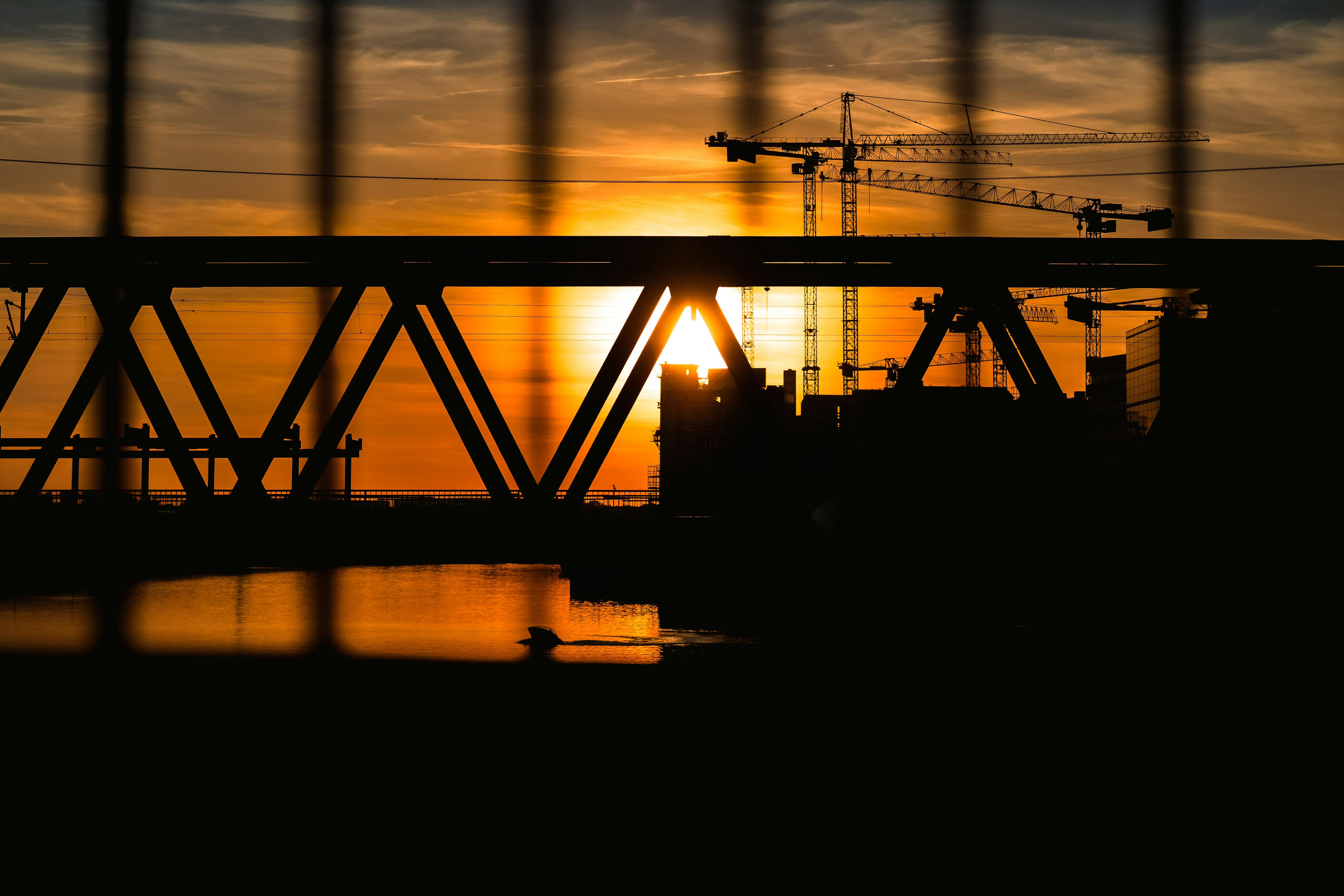 Sunset Bridge Silhouette Through Barred Glass