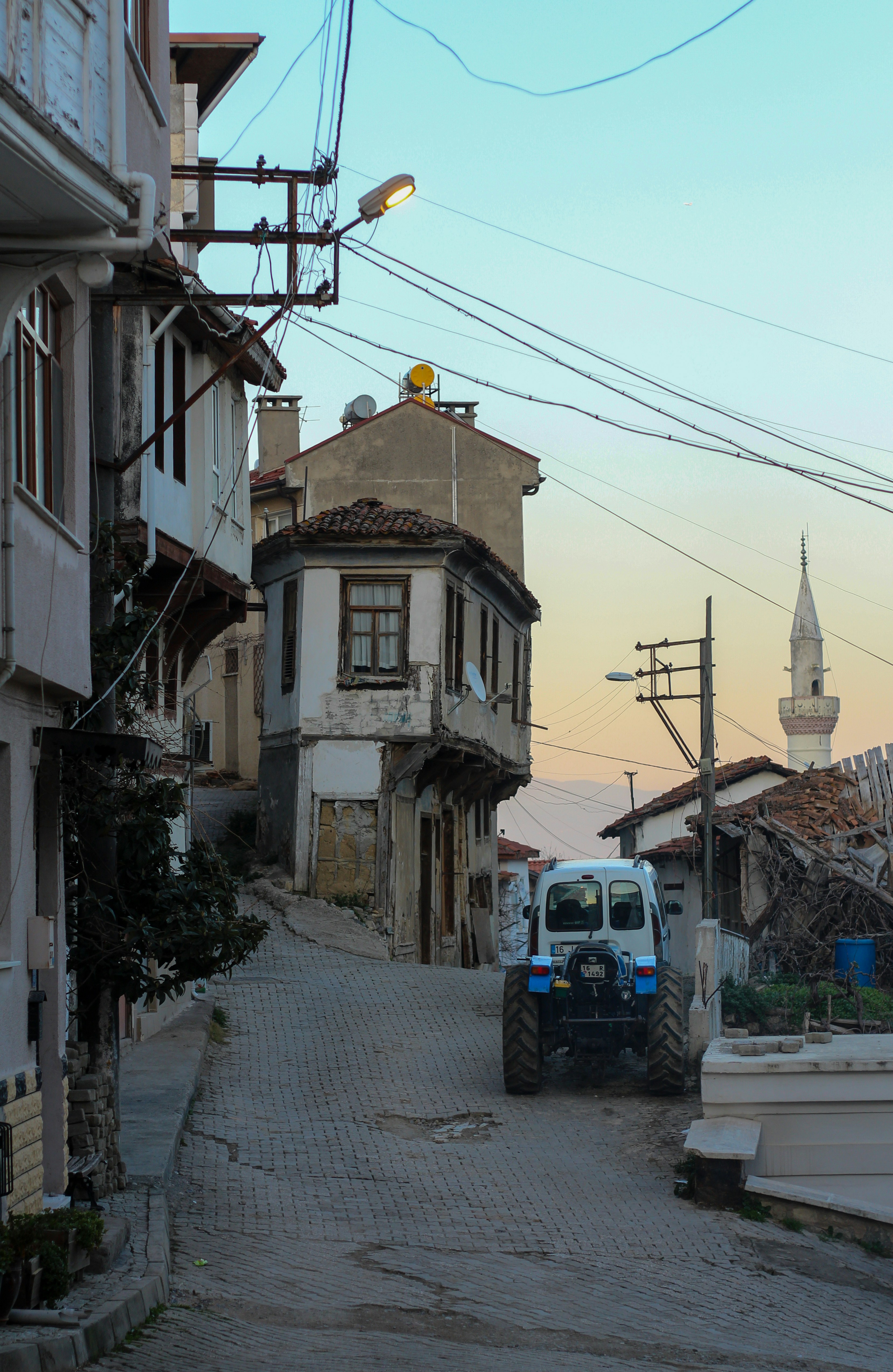 Sunlit Alley and Tractor of a Hillside Village