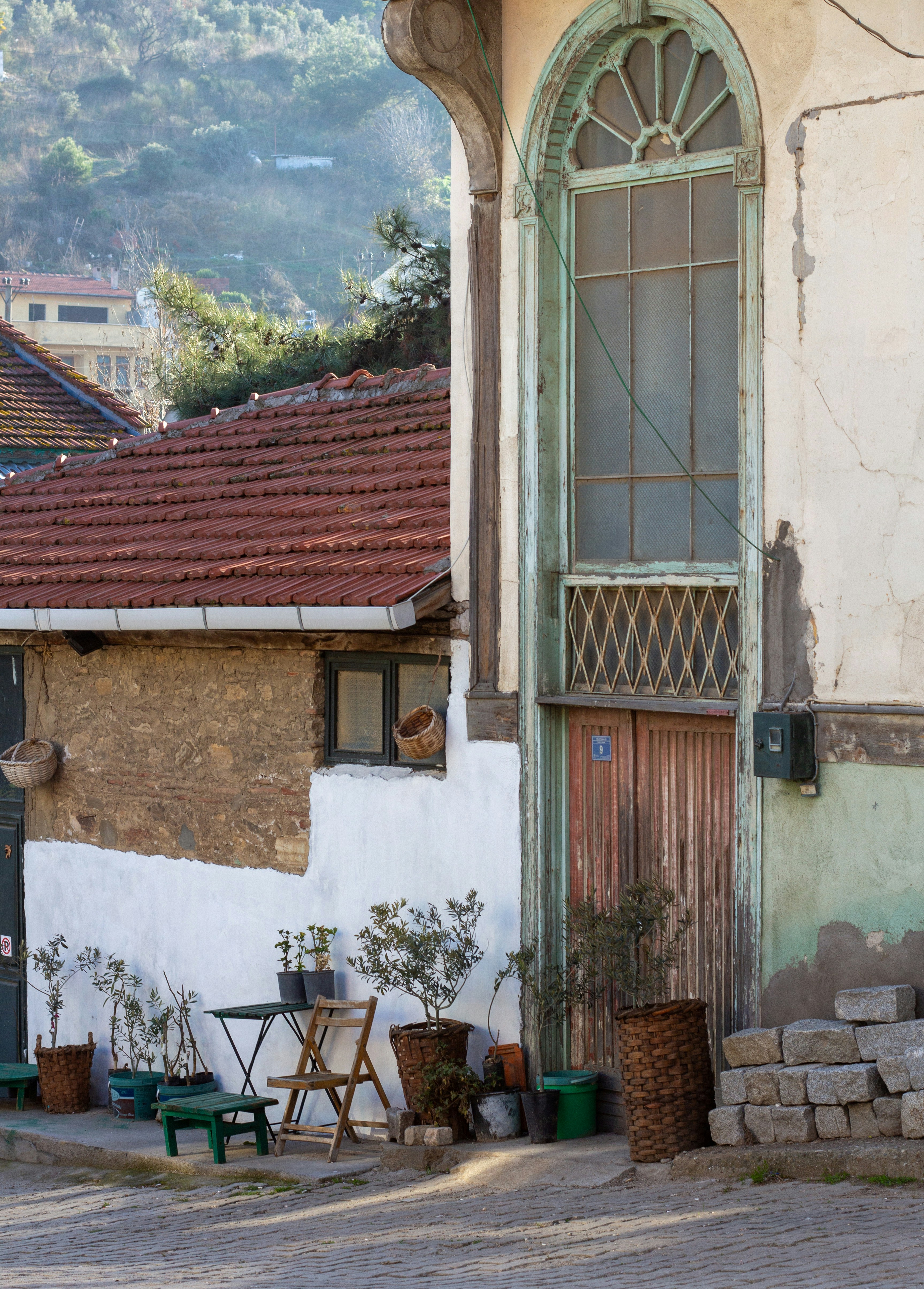 Weathered doorway with weather-beaten façade and rustic courtyard dining