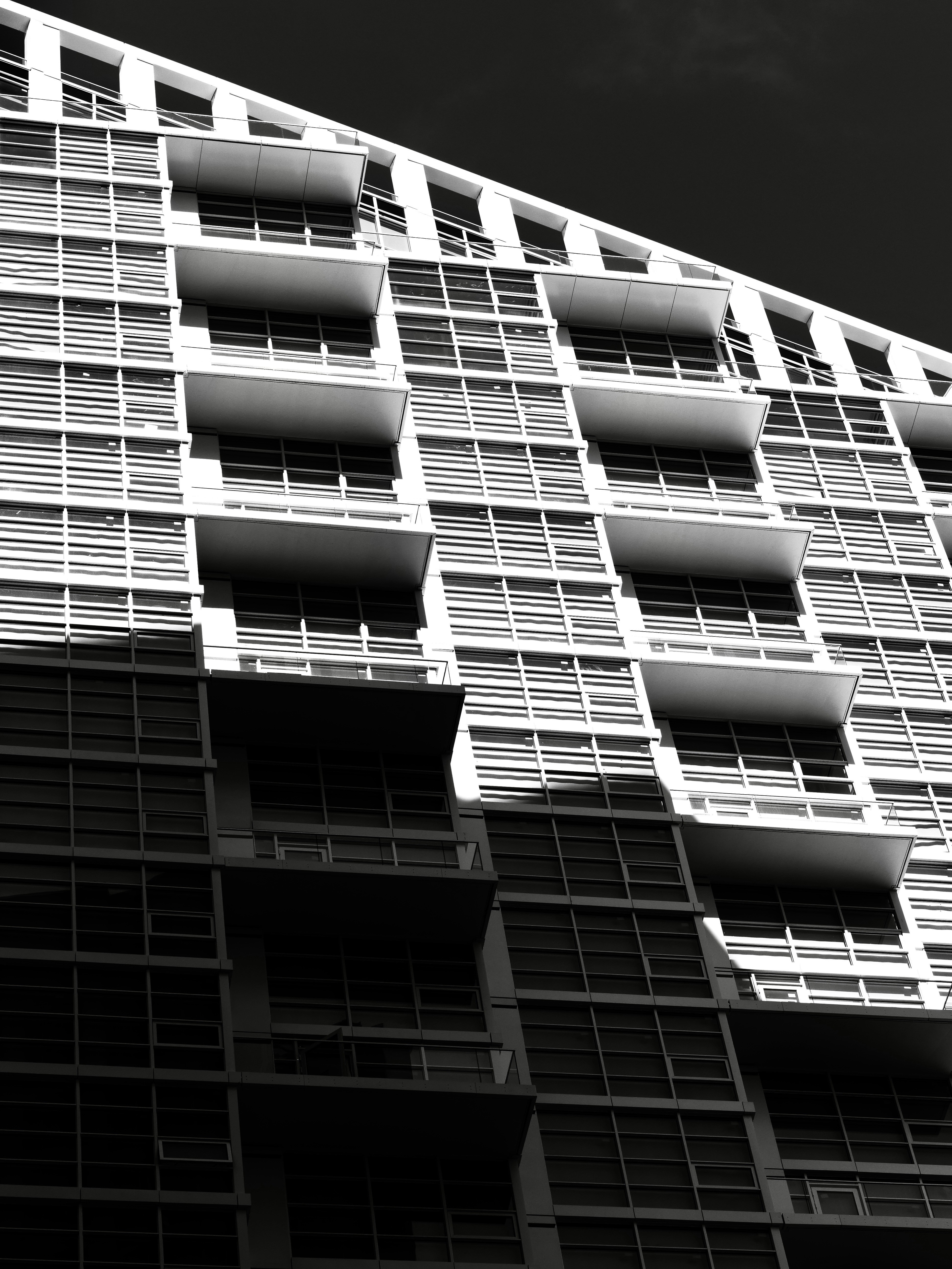 Architectural Rhythm: Receding balconies in high-contrast grid