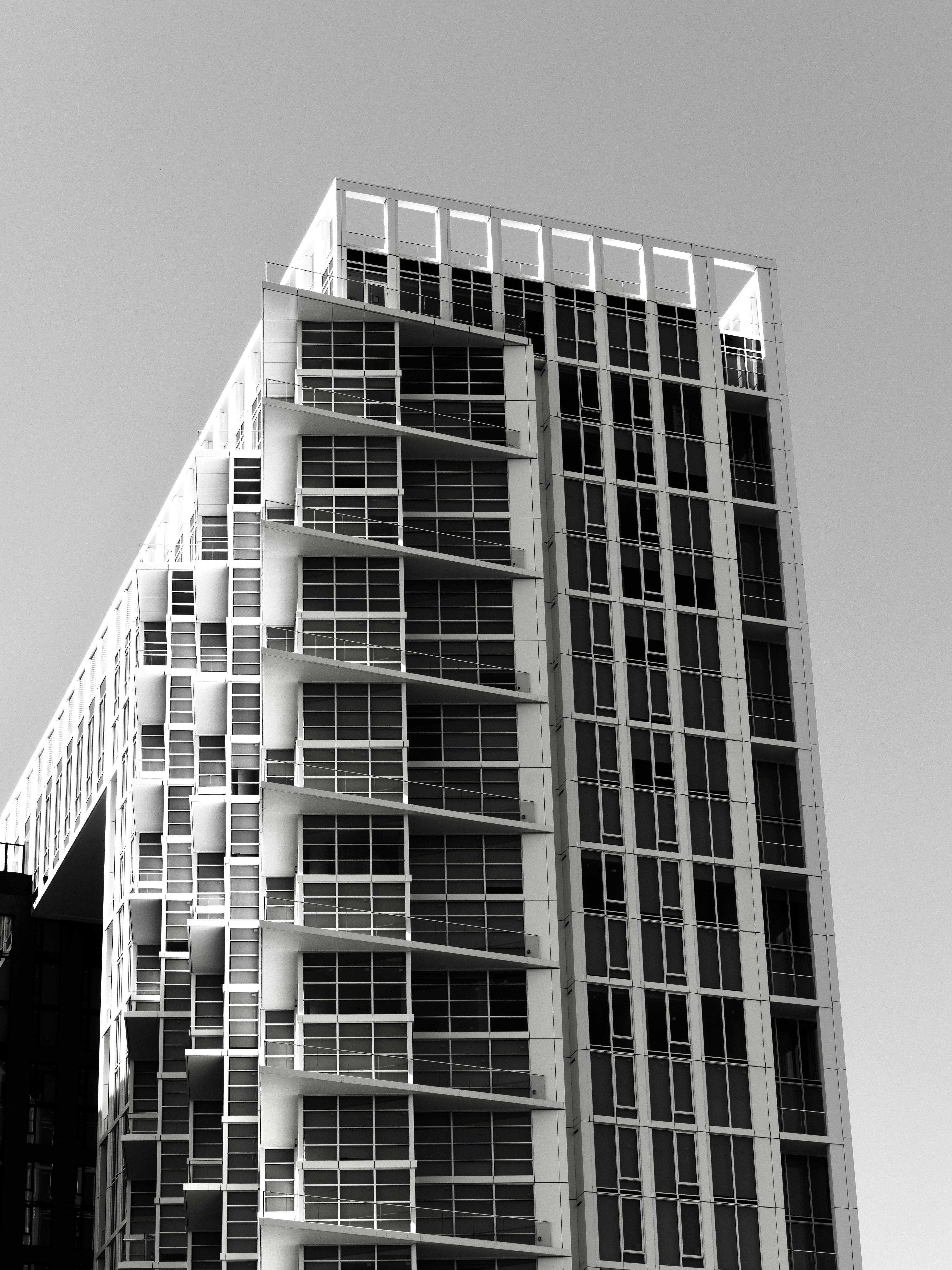 Concrete Rhythm: A Tower of Recessed Grids and Shadowed Balconies