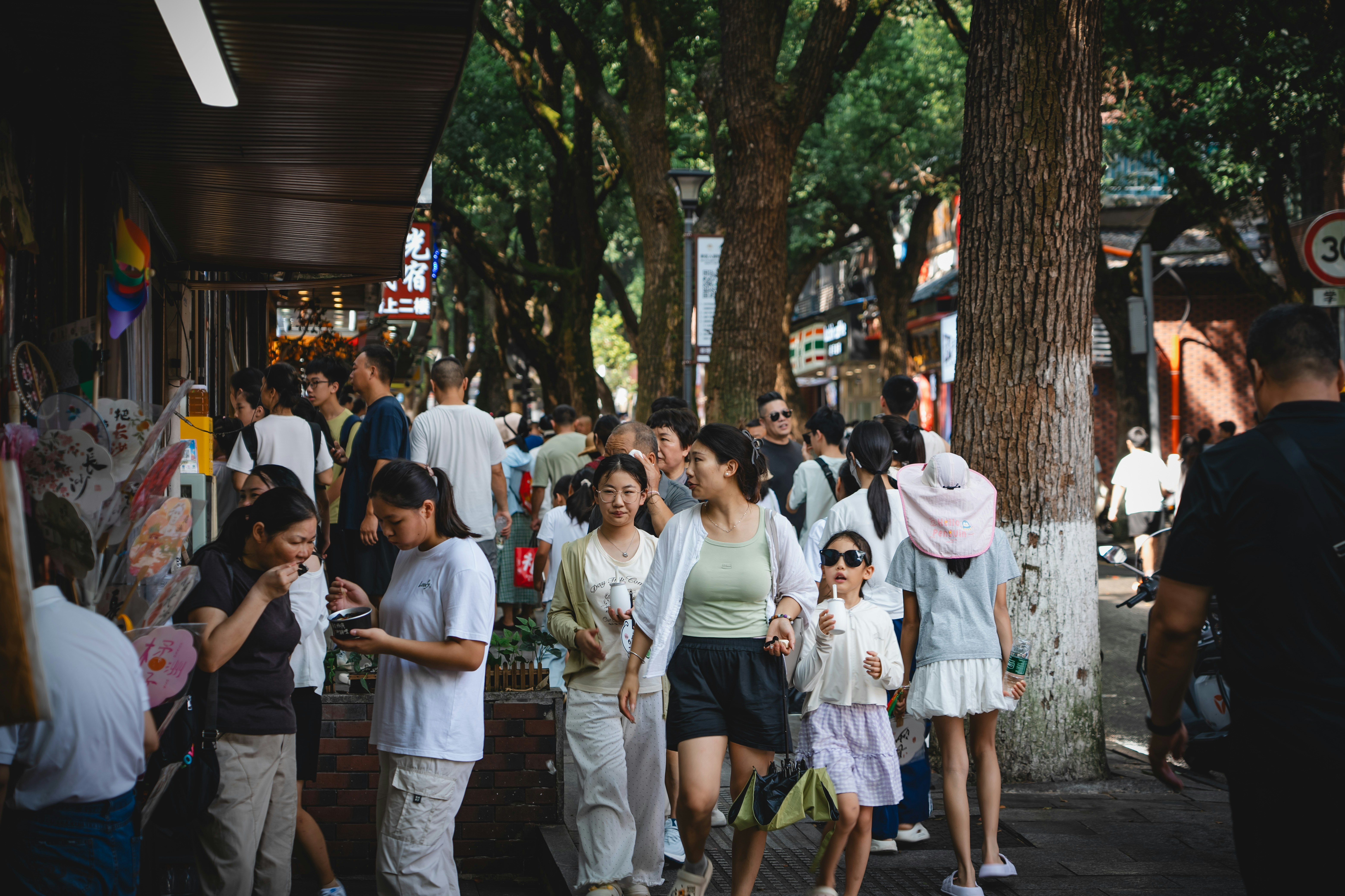 Crowd in a Busy Street Market: Colorful Interactions Amid Urban Shade