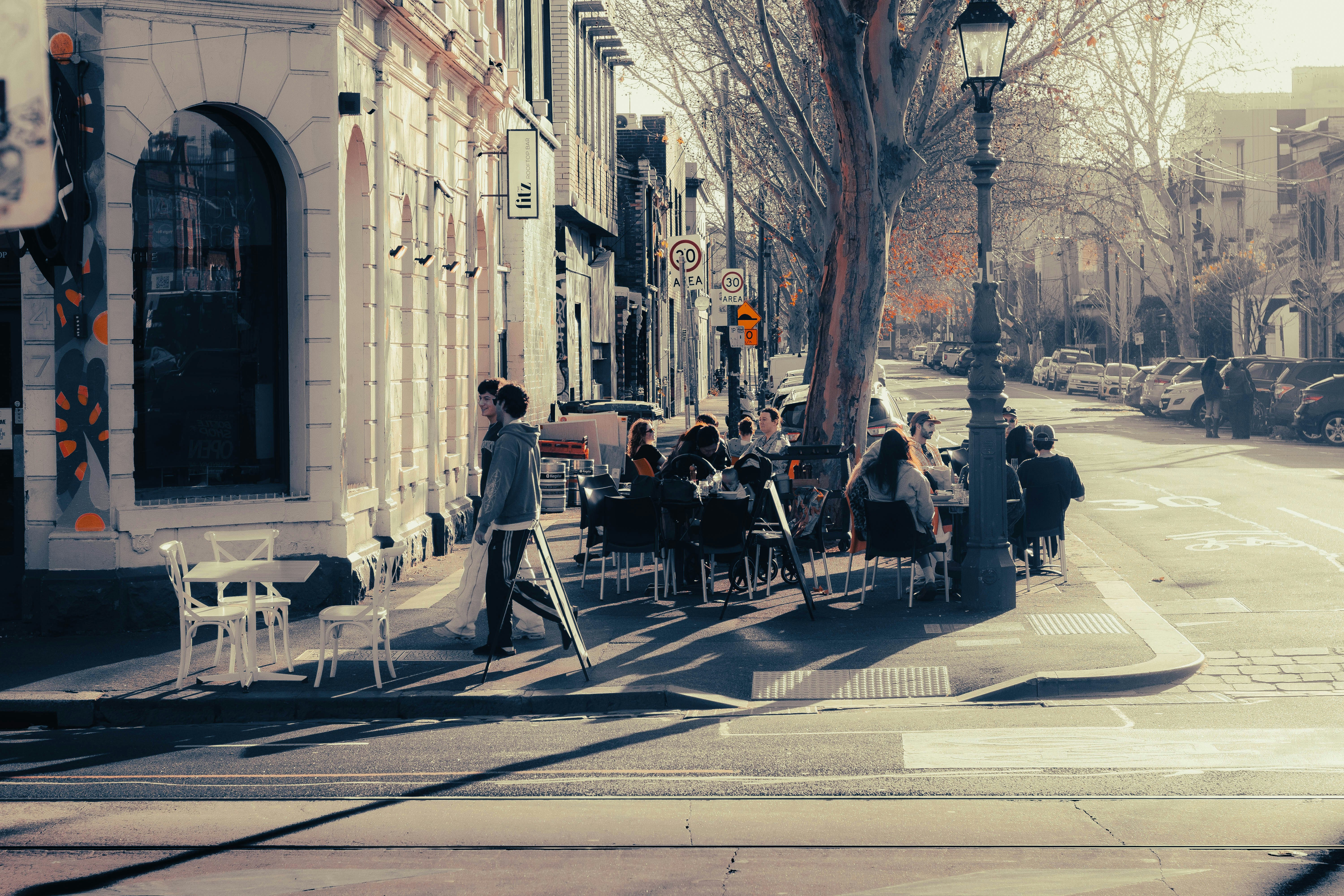 Café Street Pulse: Evening Shadows on a Busy Corner