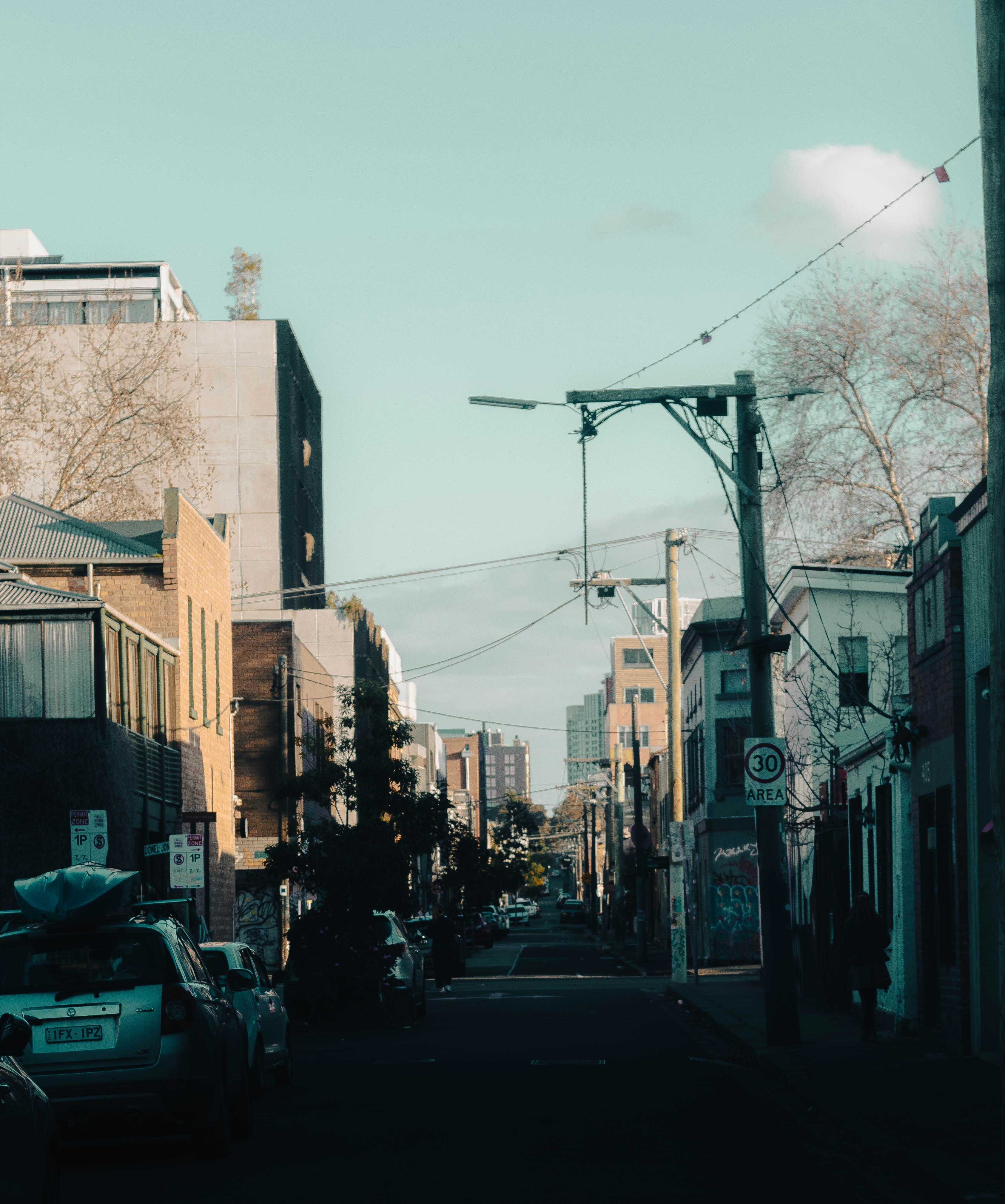 City Alleyway: Distant Blue Sky Over Quiet Street