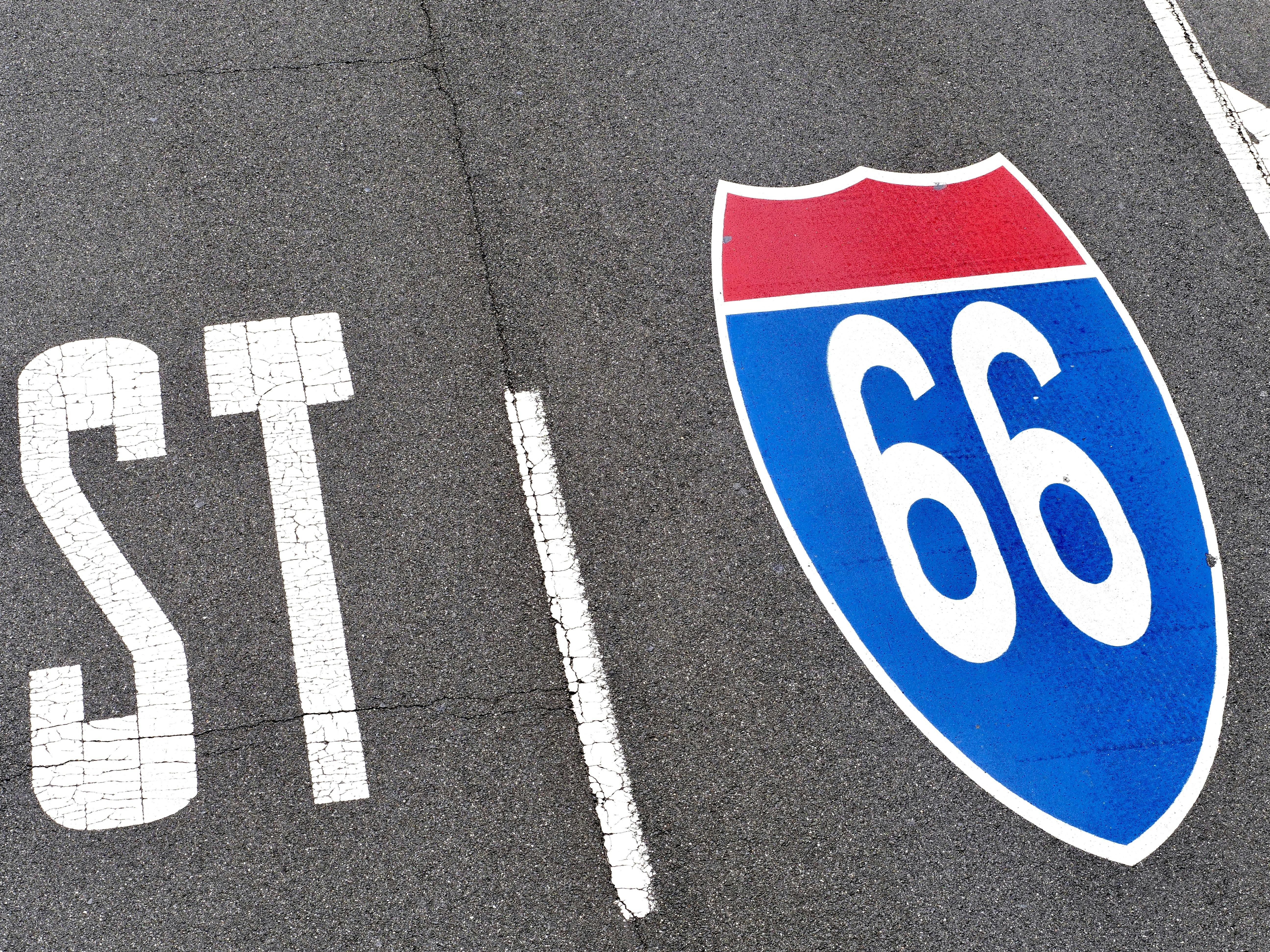 Route 66 Crest on Asphalt: A Close-Up of a Historic Shield