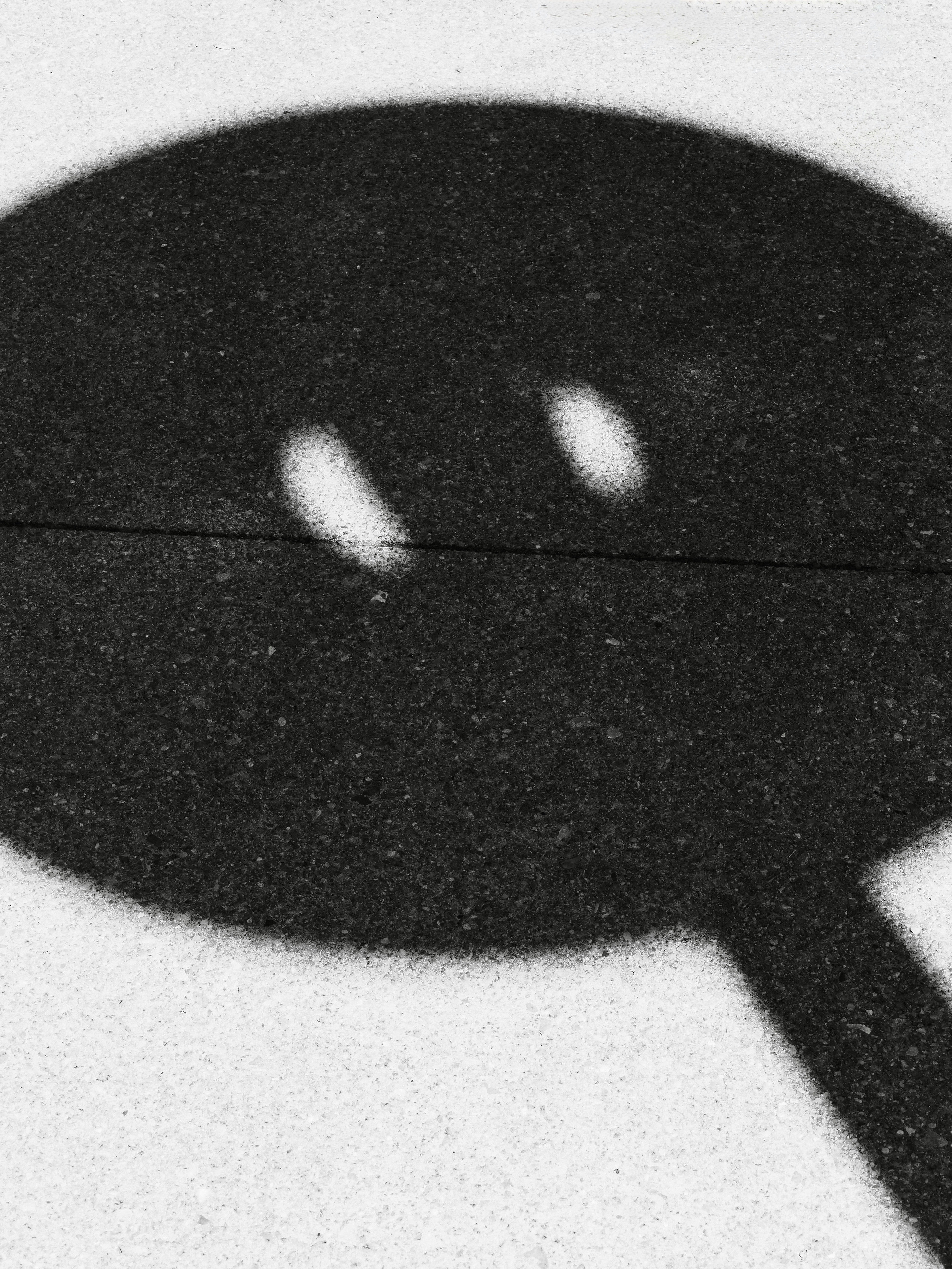 Abstract Spotlight: Close-up of a Dark Elliptical Shape with White Highlights