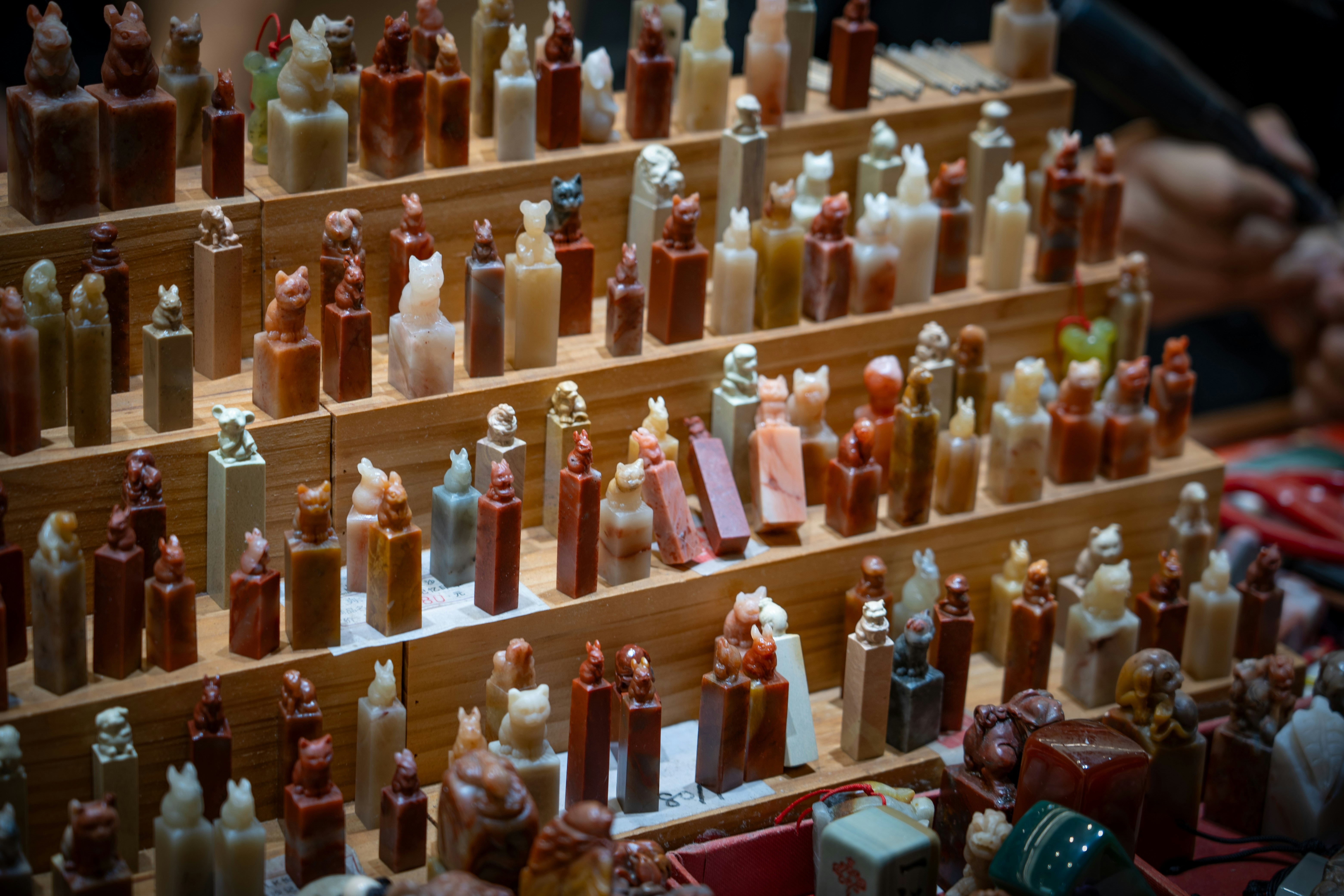 Tiered Row of Wax Candles: a Spectrum of Hues on Wooden Steps