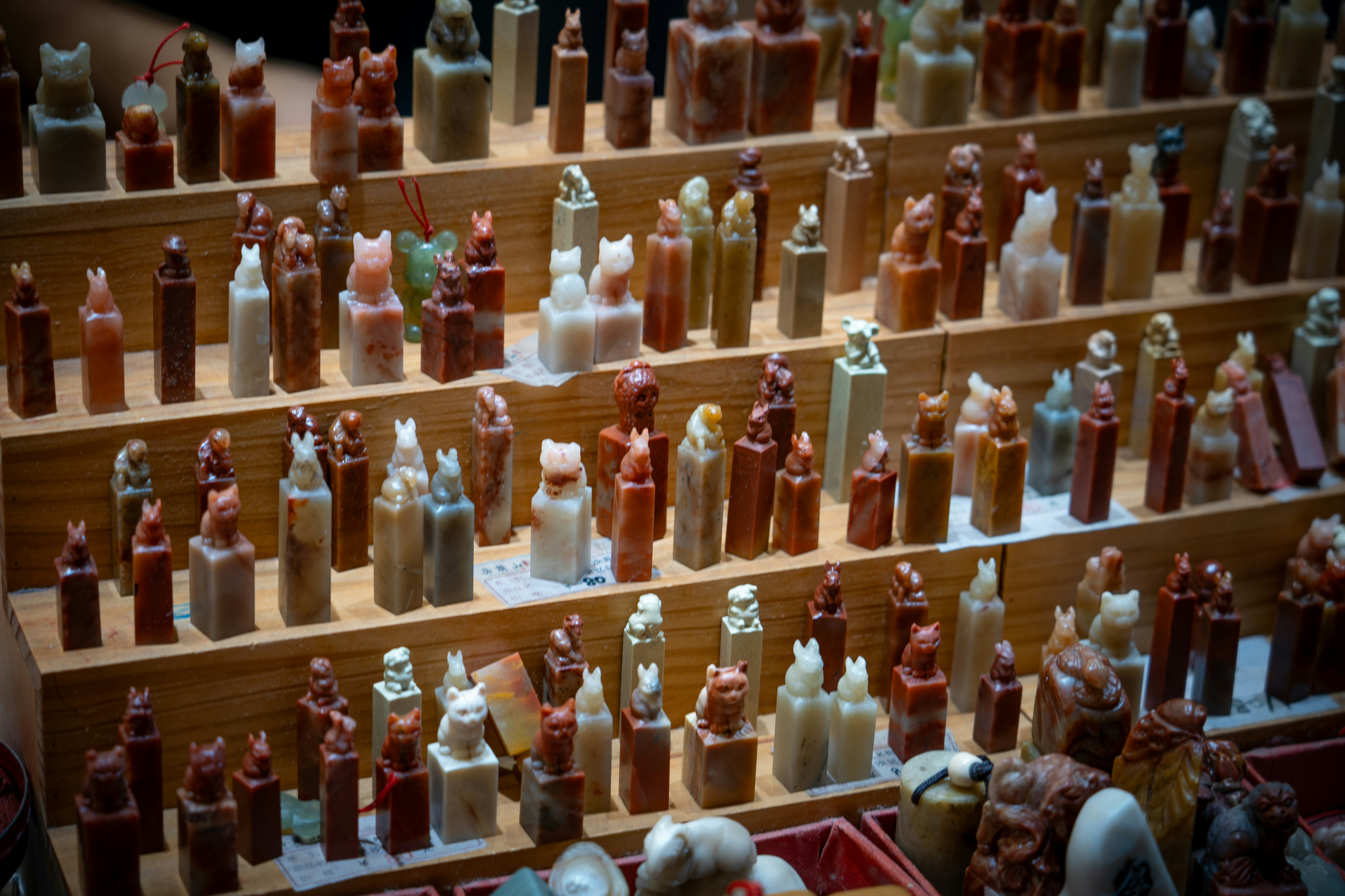 A sea of candle carvings: carved figurines in a stepped display