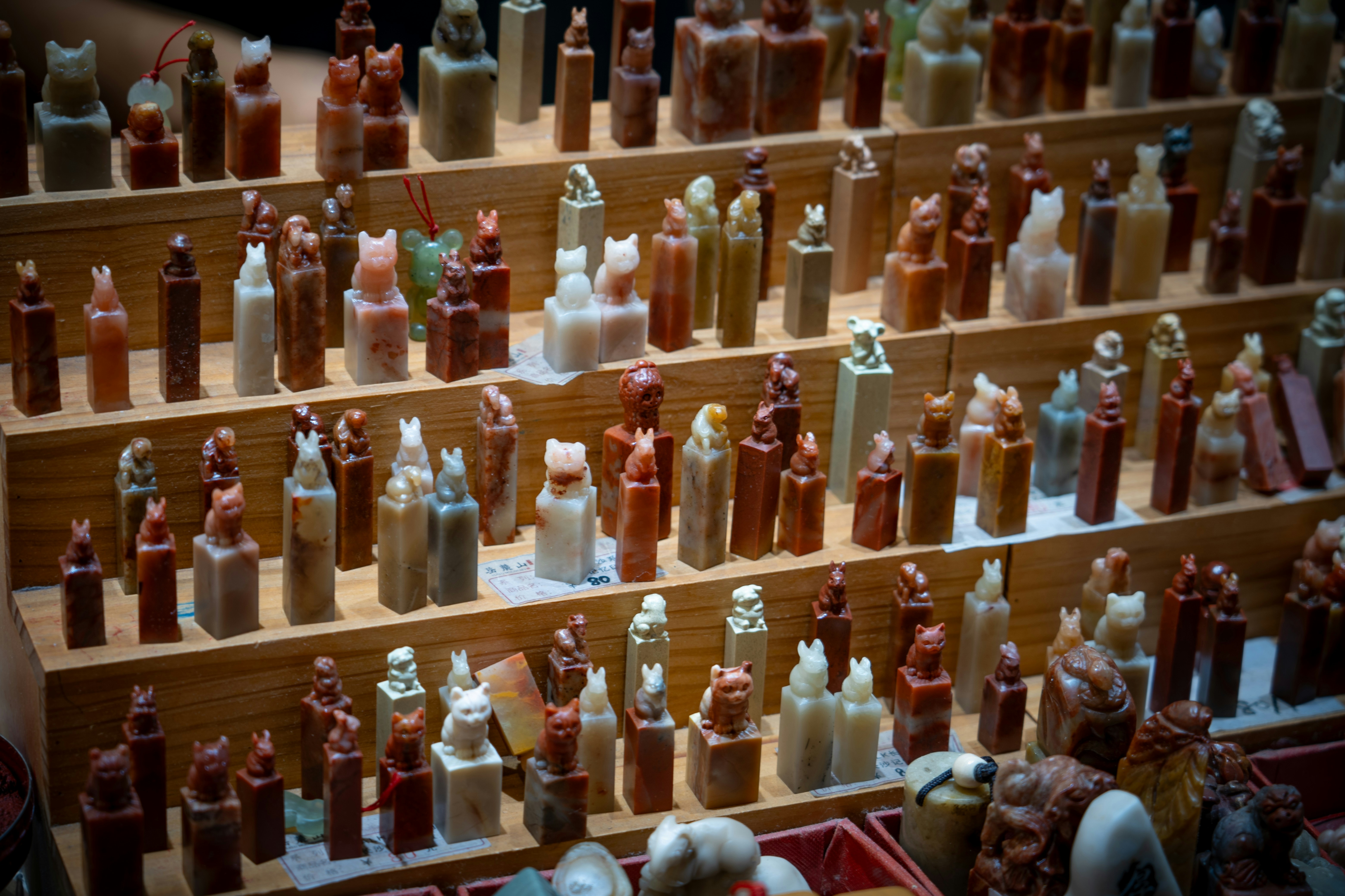 Rows of Tiny Wax Figures: A Cabinet of Colored Candled Statues