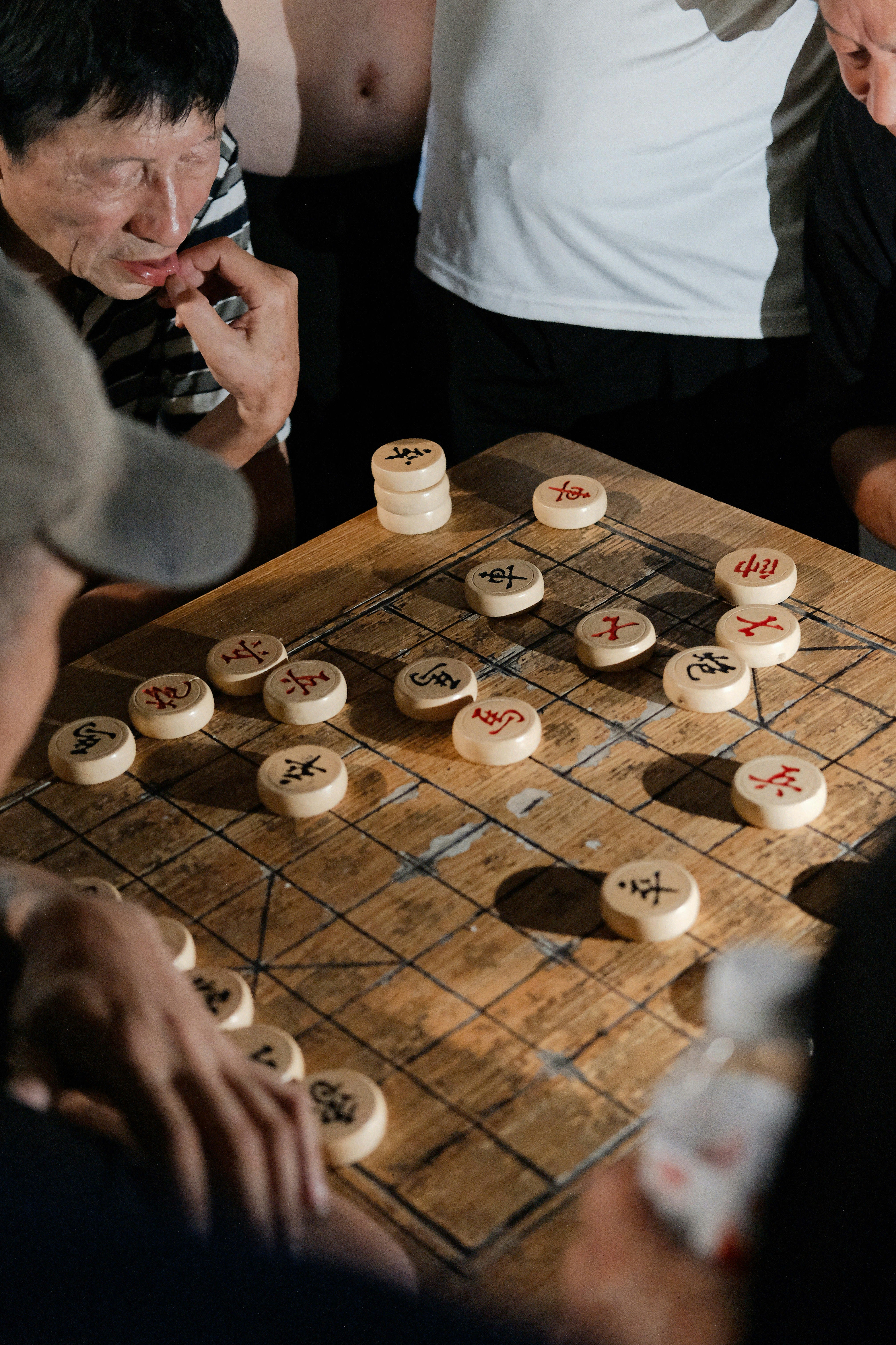 Duel of Tokens: A Focused Moment Over the Wooden Board