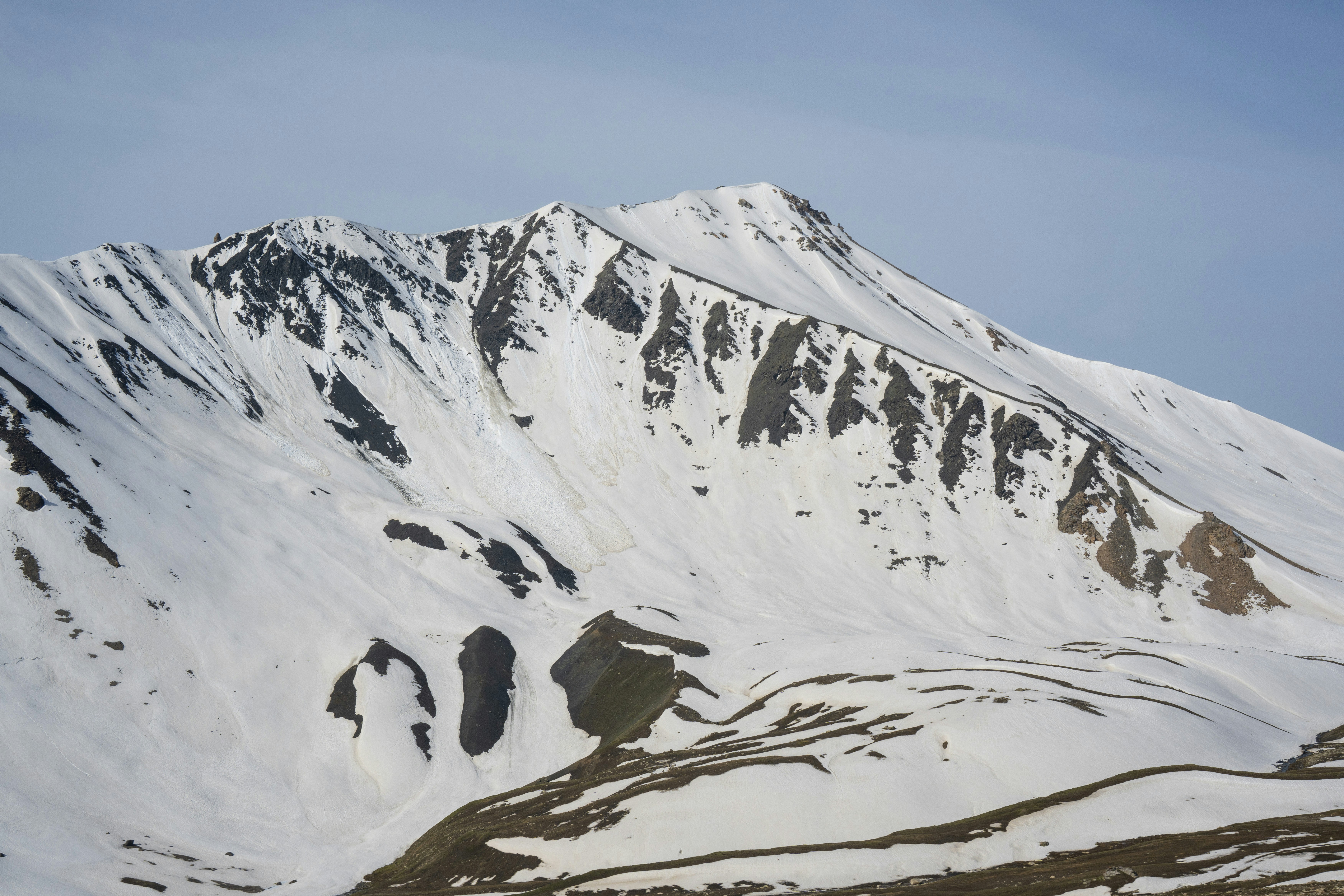Snowbound Ridge Under Clear Alpine Sky