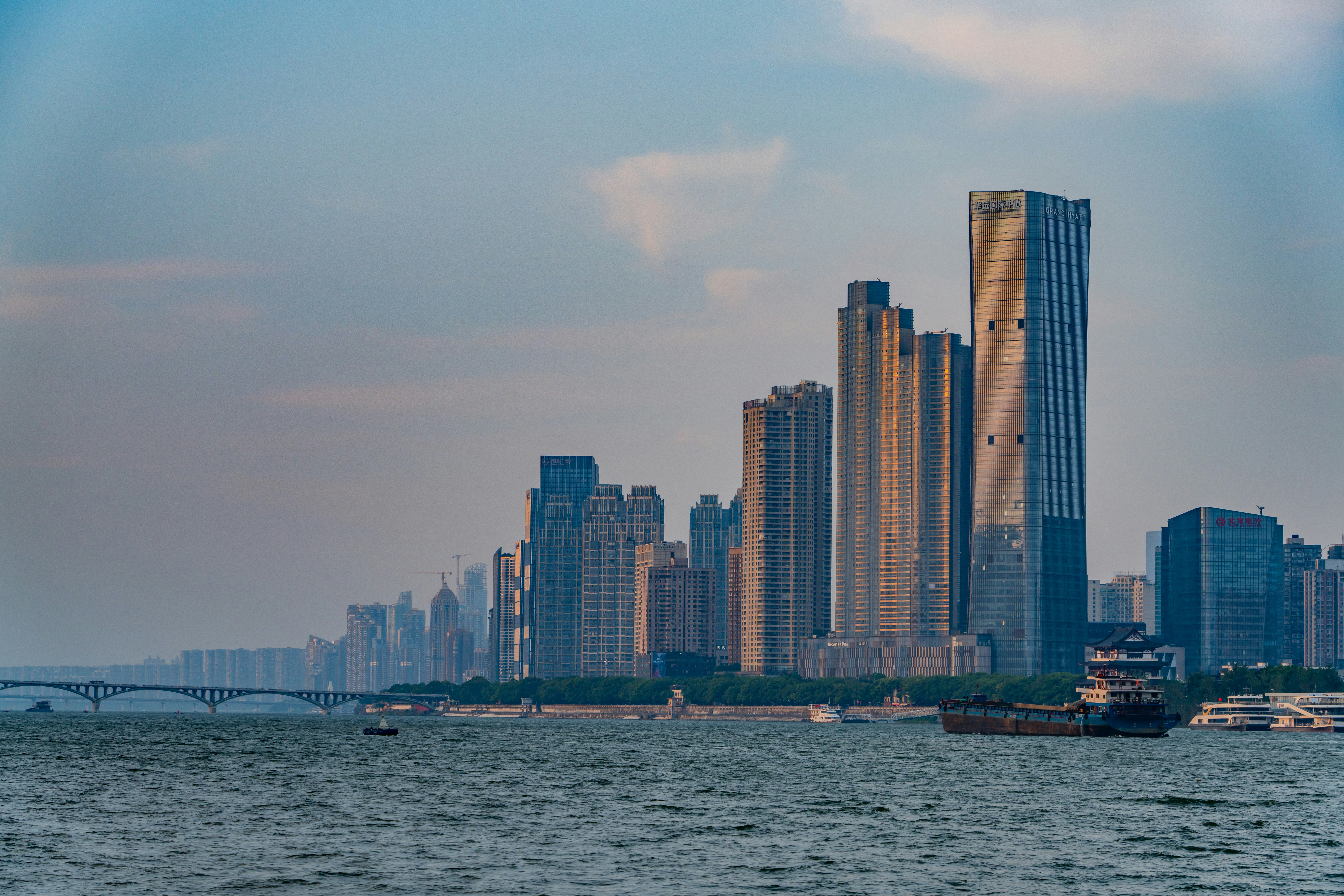 Sunlit Skyline Rising Over Quiet Waters