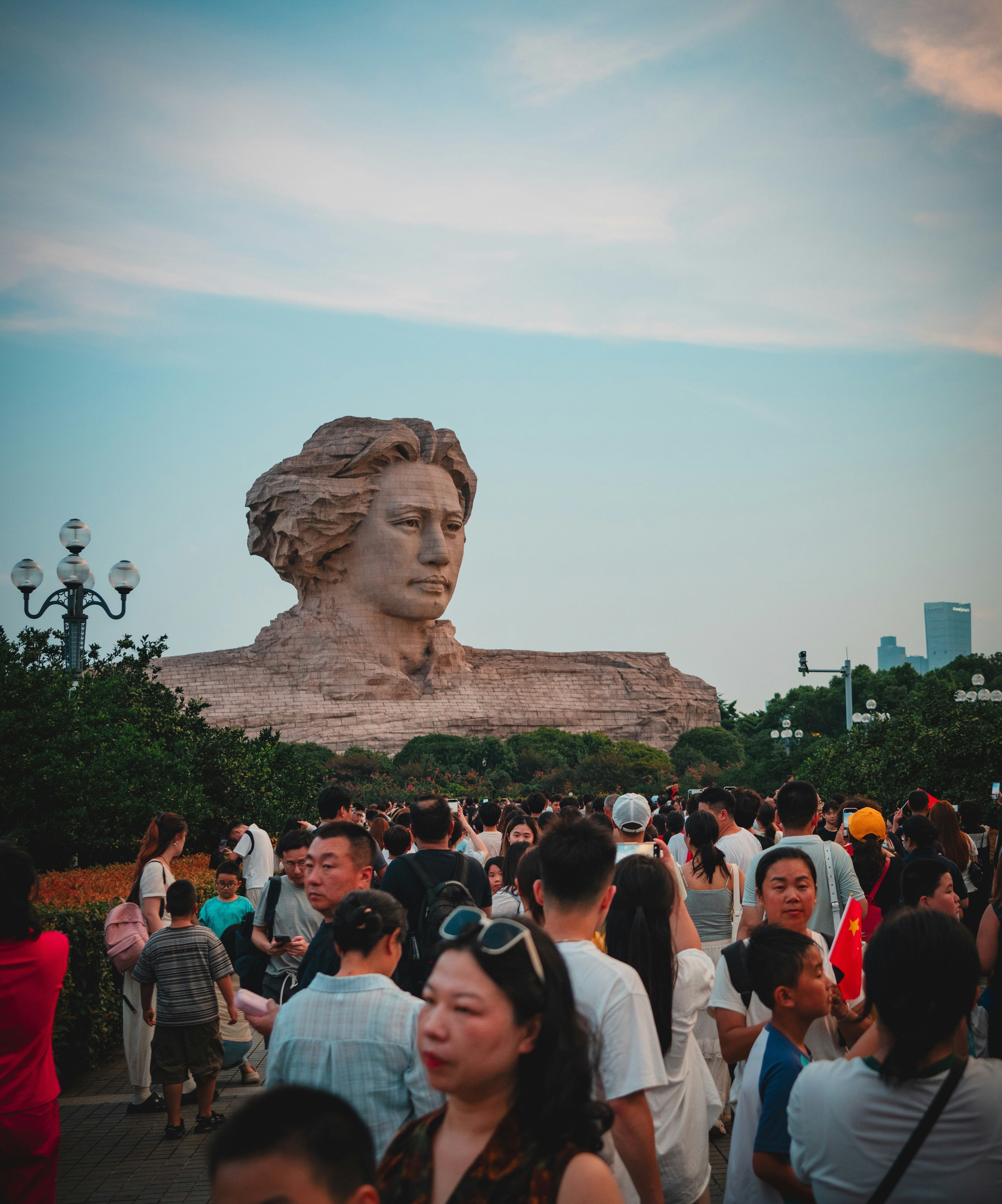 Stone Whisperer: A Monumental Portrait Among the City’s Crowd
