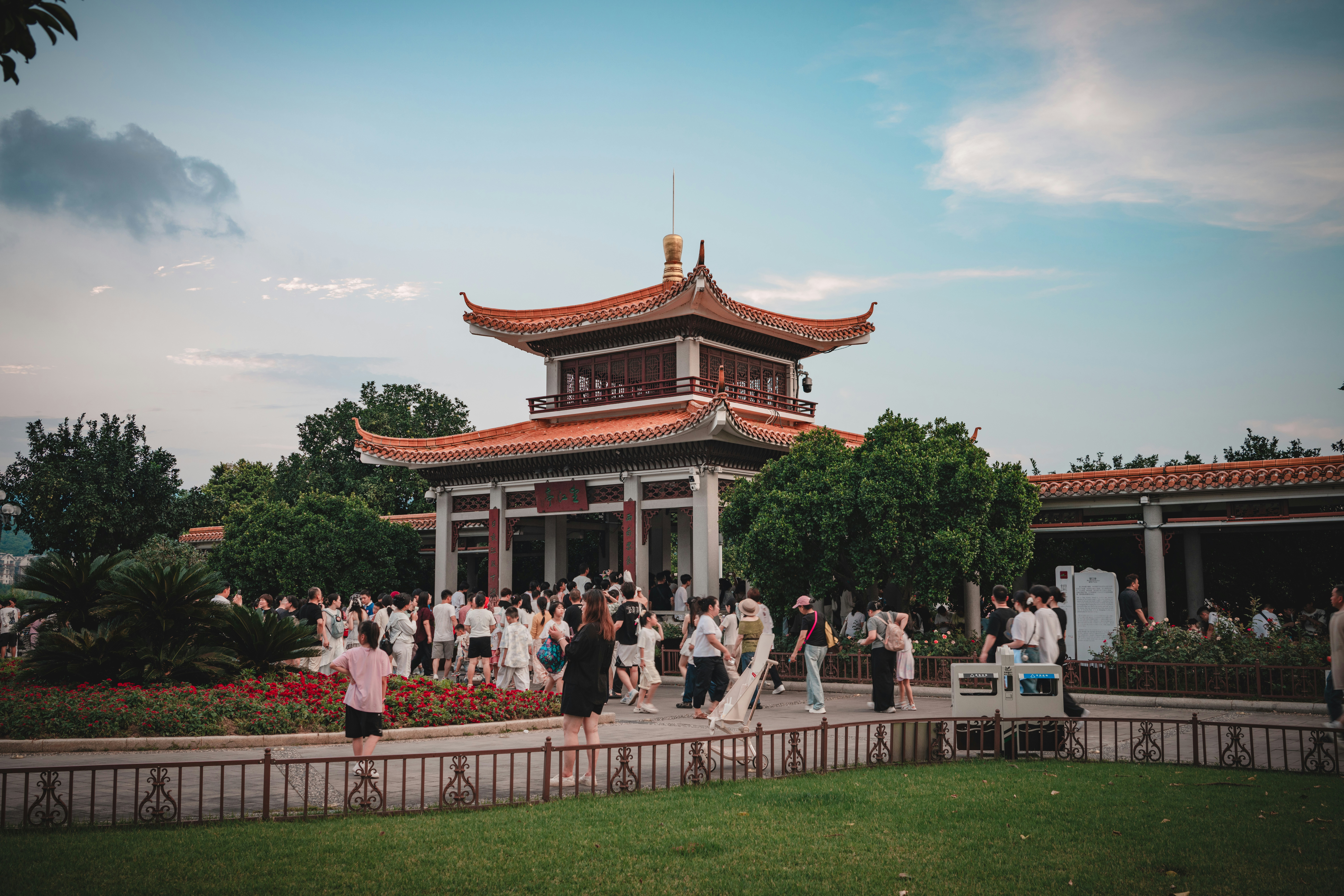 Temple Courtyard in Bloom: A Bustling Gathering at Dappled Dusk