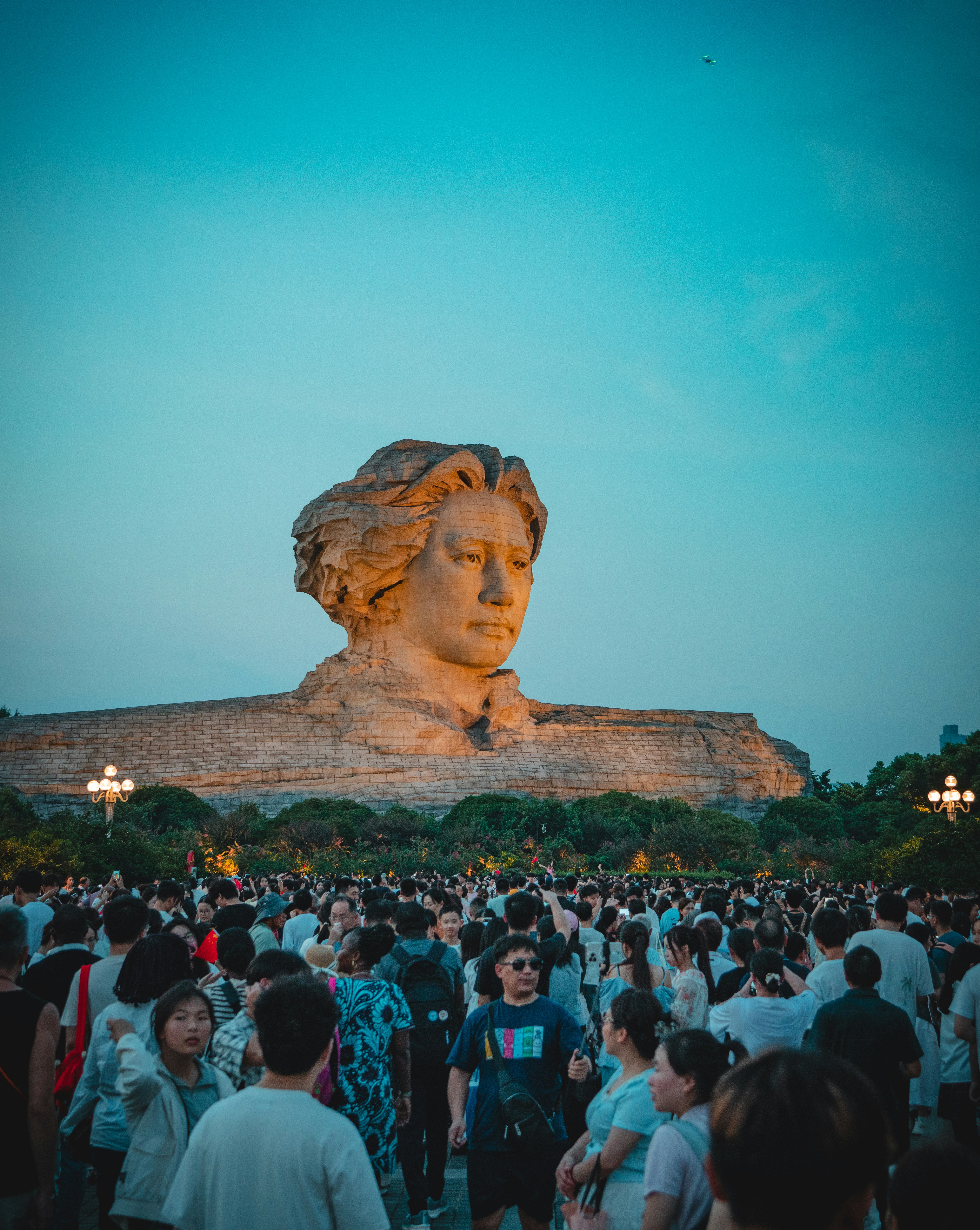The People Gate: A Crowd Beneath the Giant Stone Portrait