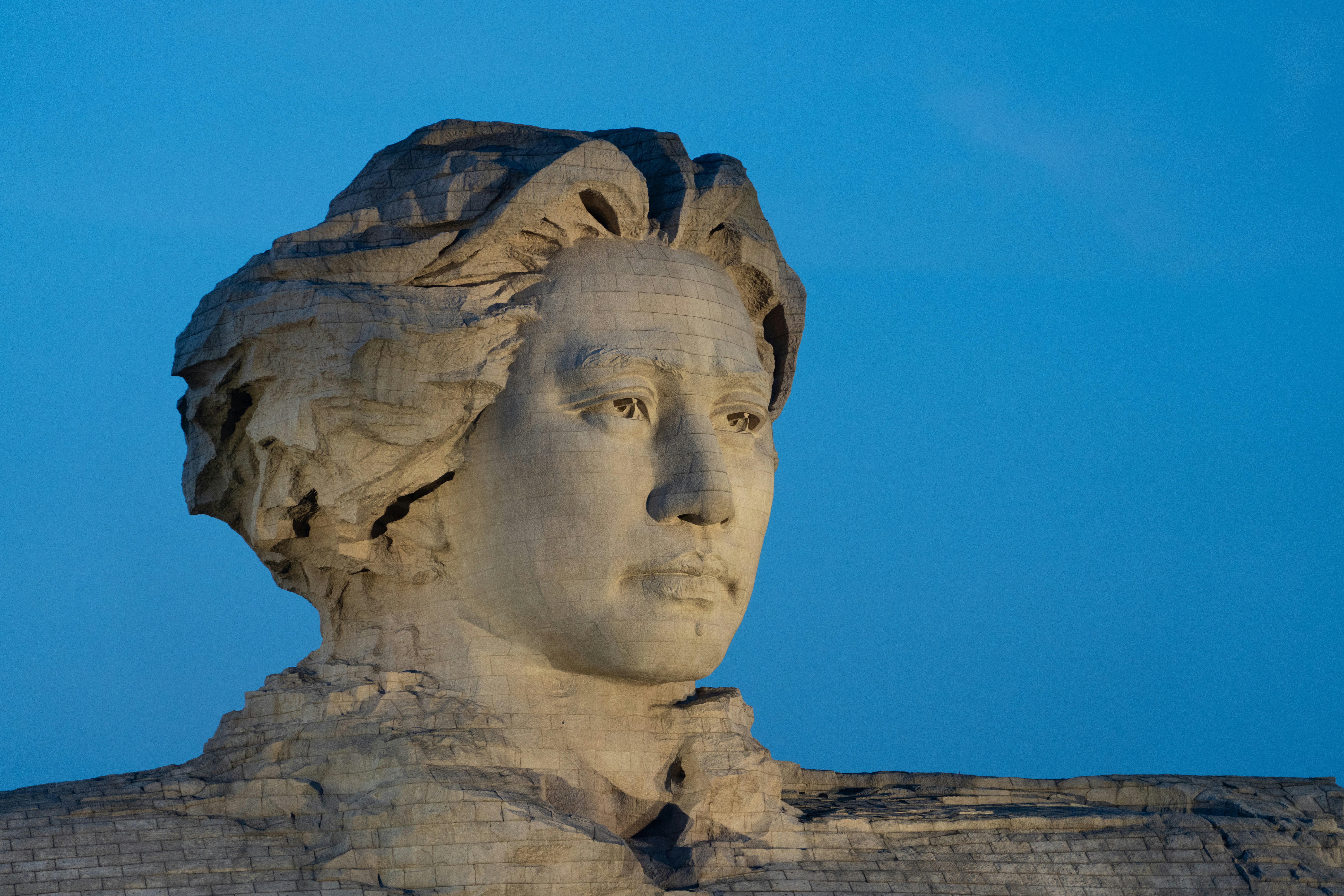 Stone Portrait of Quiet Resolve under a Pale Sky