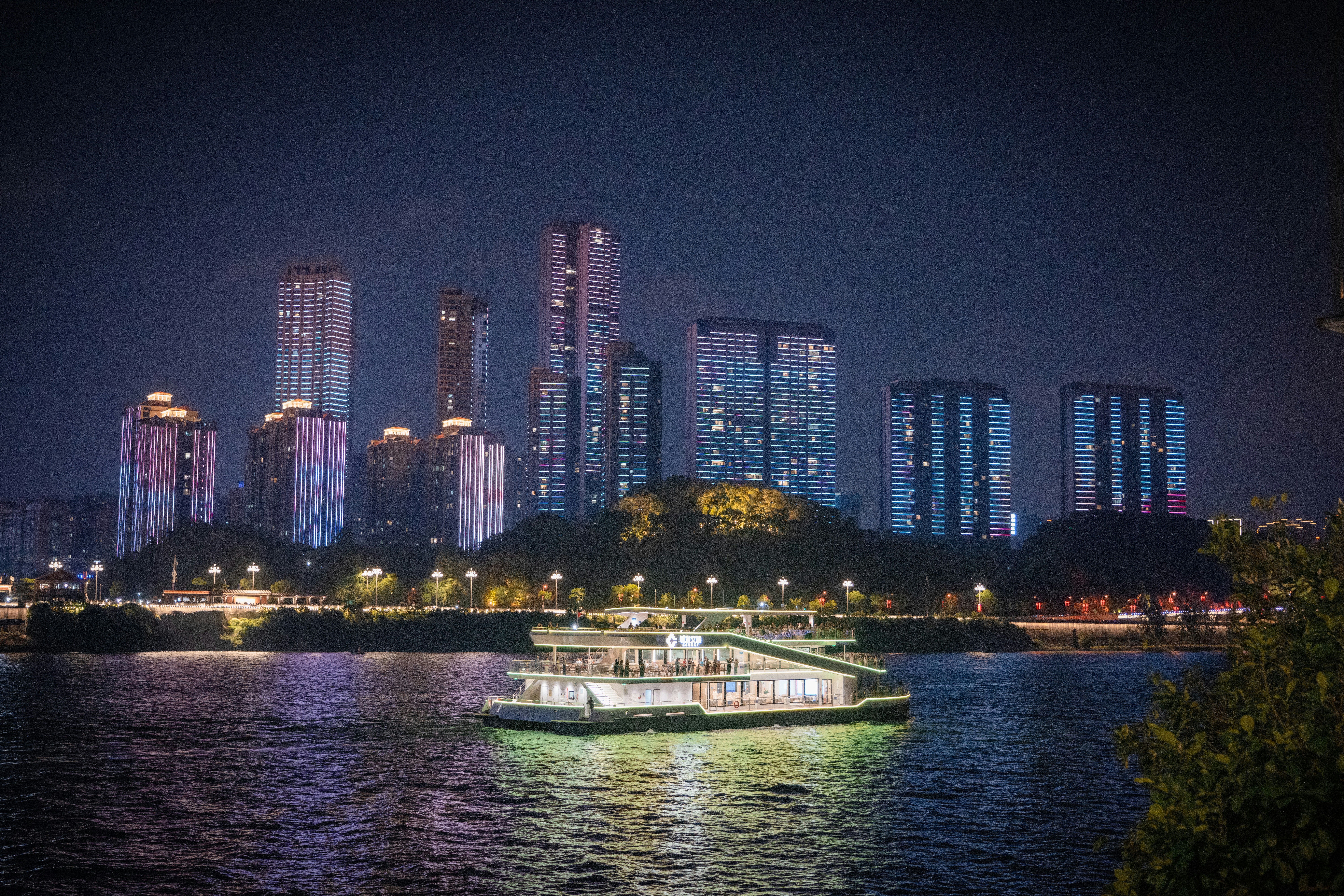 Nighttime River Parade Under City Lights