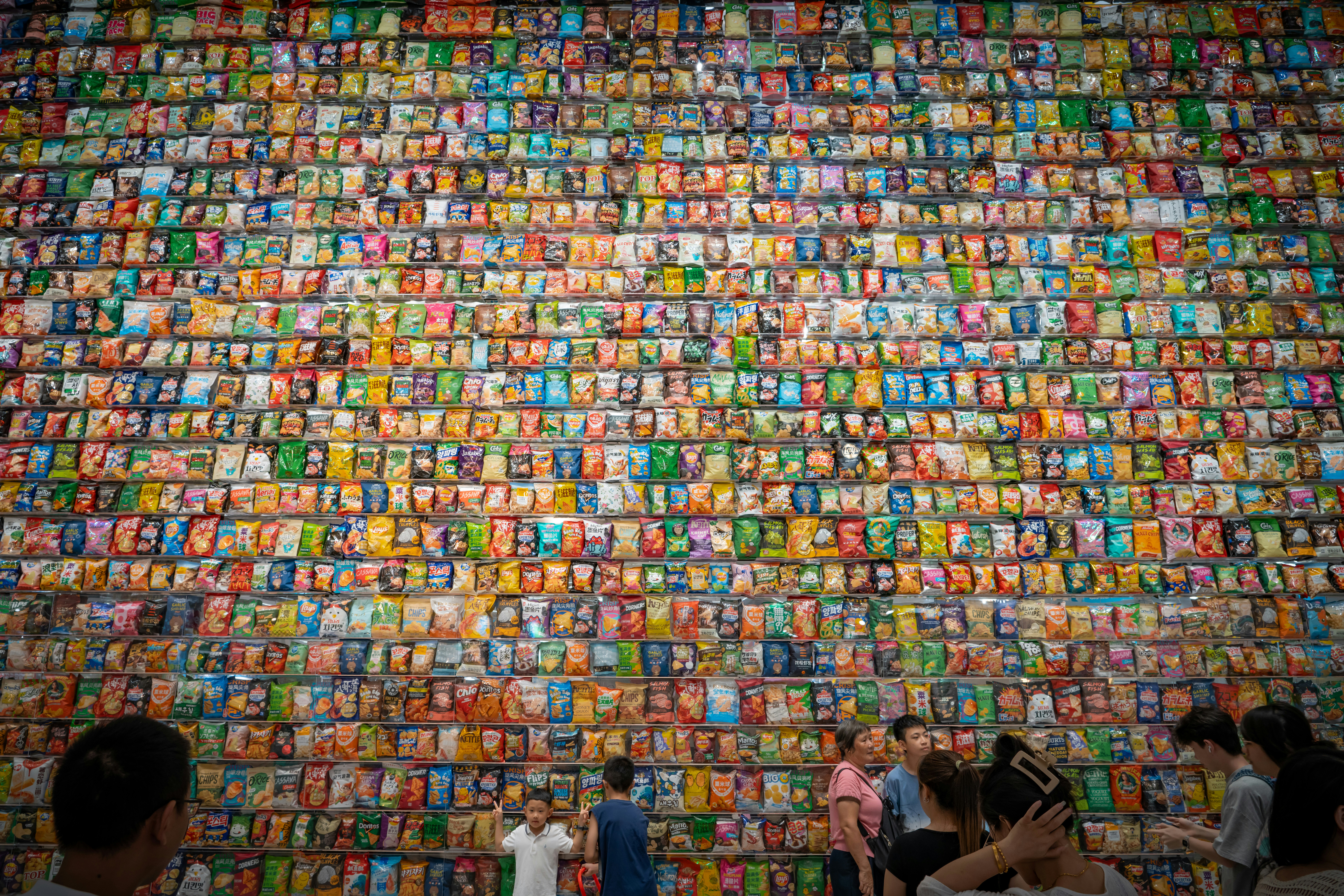 Colorful Mosaic Wall of Comics with Visitors