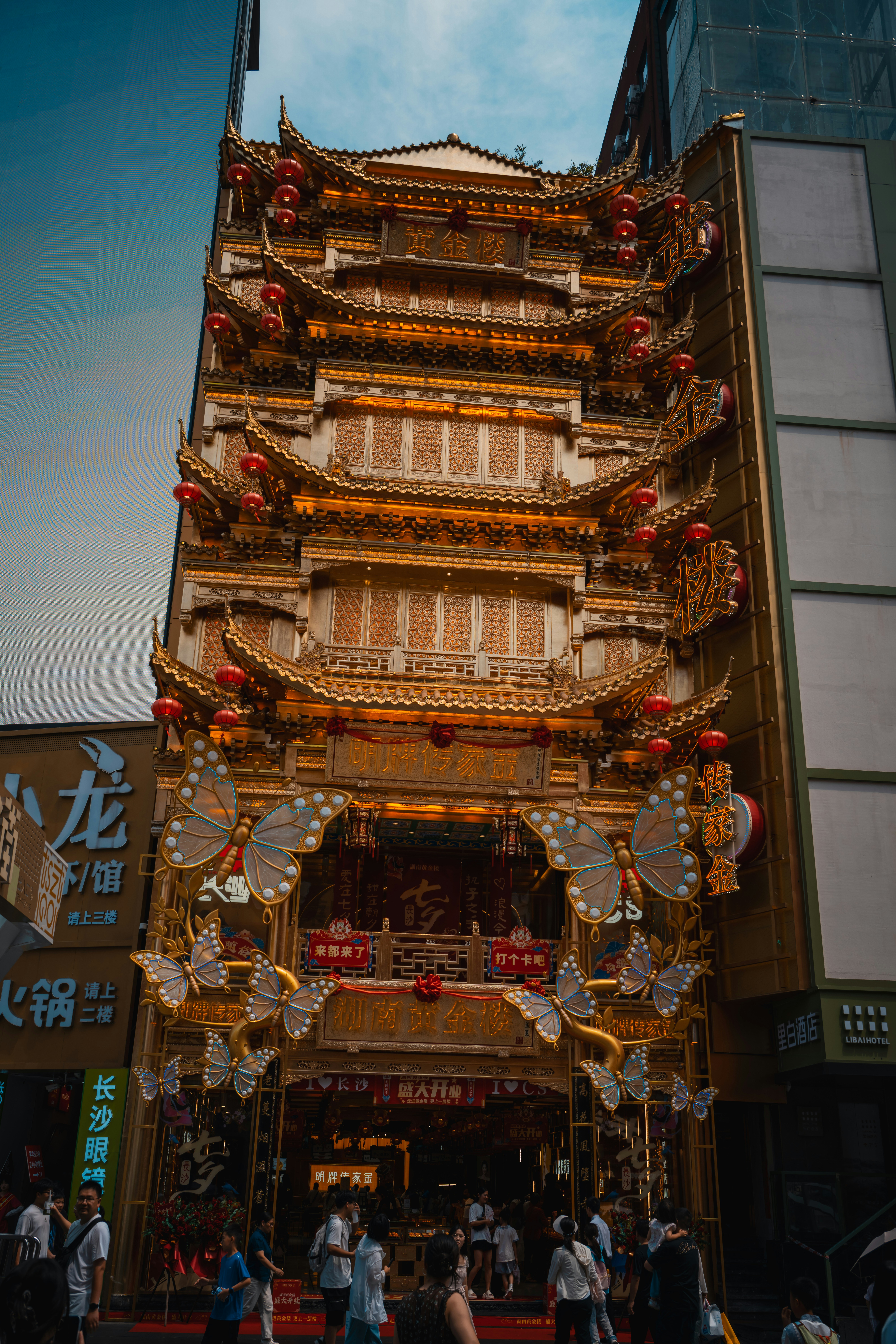 Pagoda Under Neon: A Dragon Gate Through a Bustling City Street