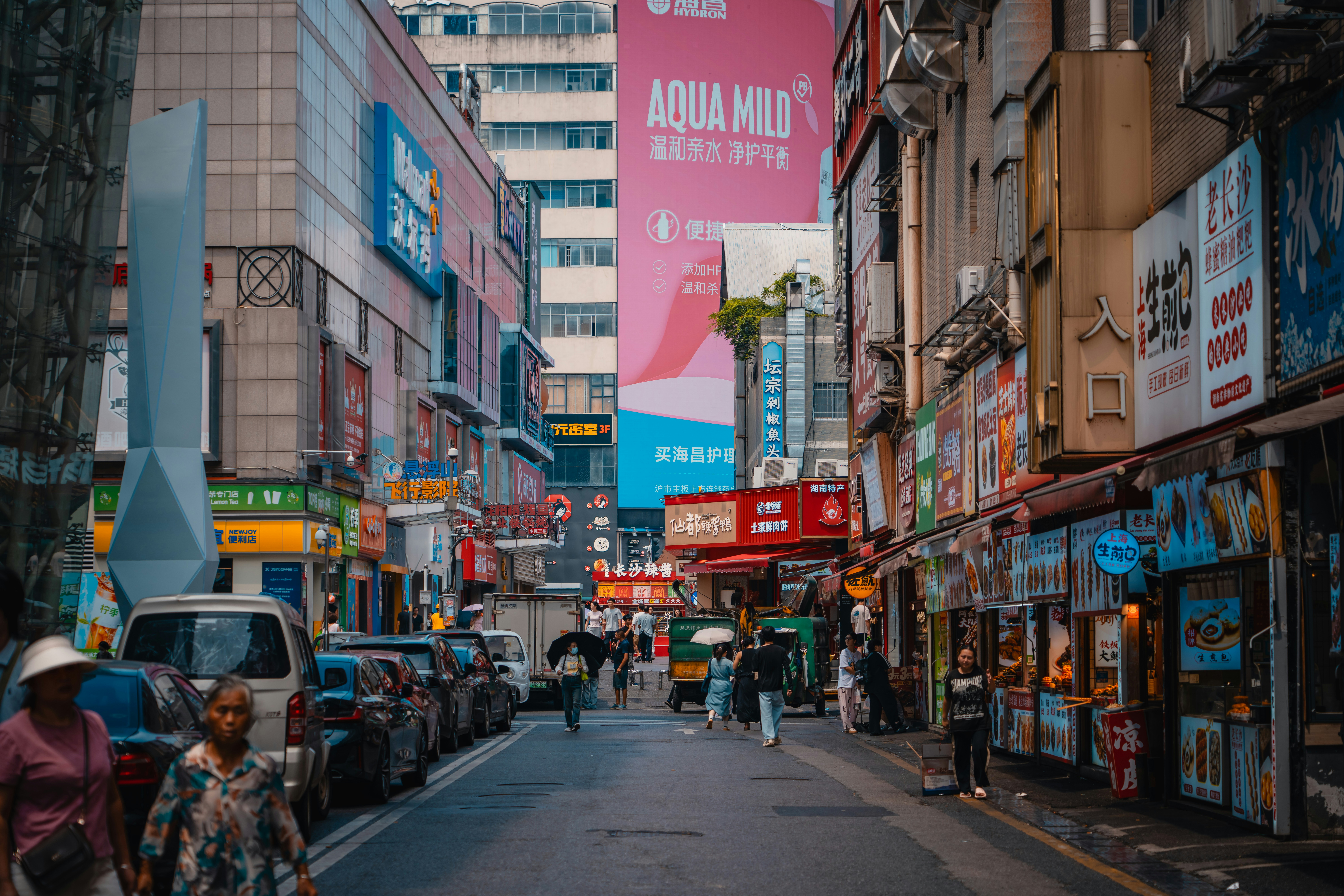 Neon Alley Pulse: A Busy Urban Strip Framed by Signage