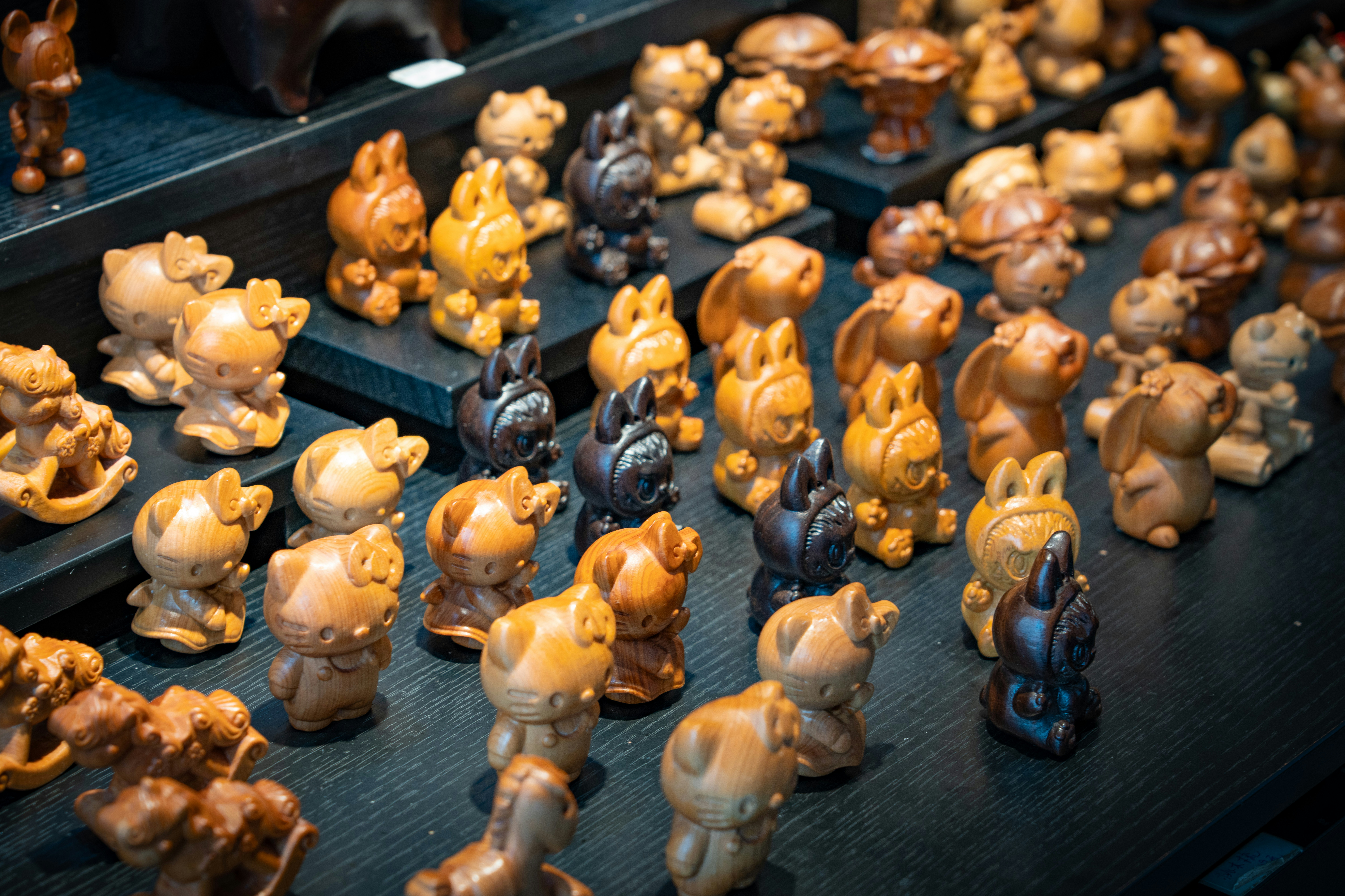 Row of Tiny Chocolate Animal Figurines on a Dark Shelf