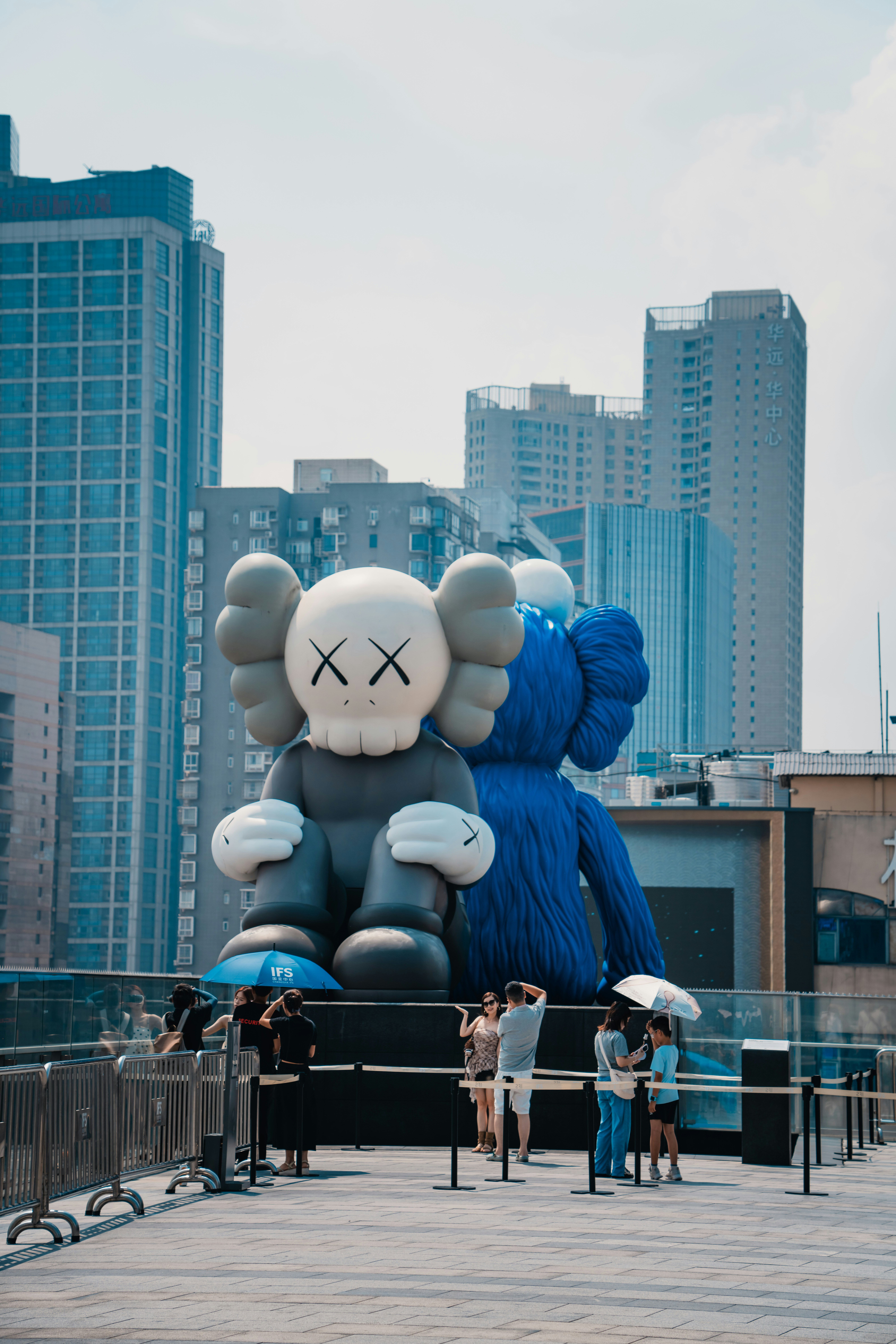 Gigantic Kaws–inspired sculpture dominates a cityscape plaza