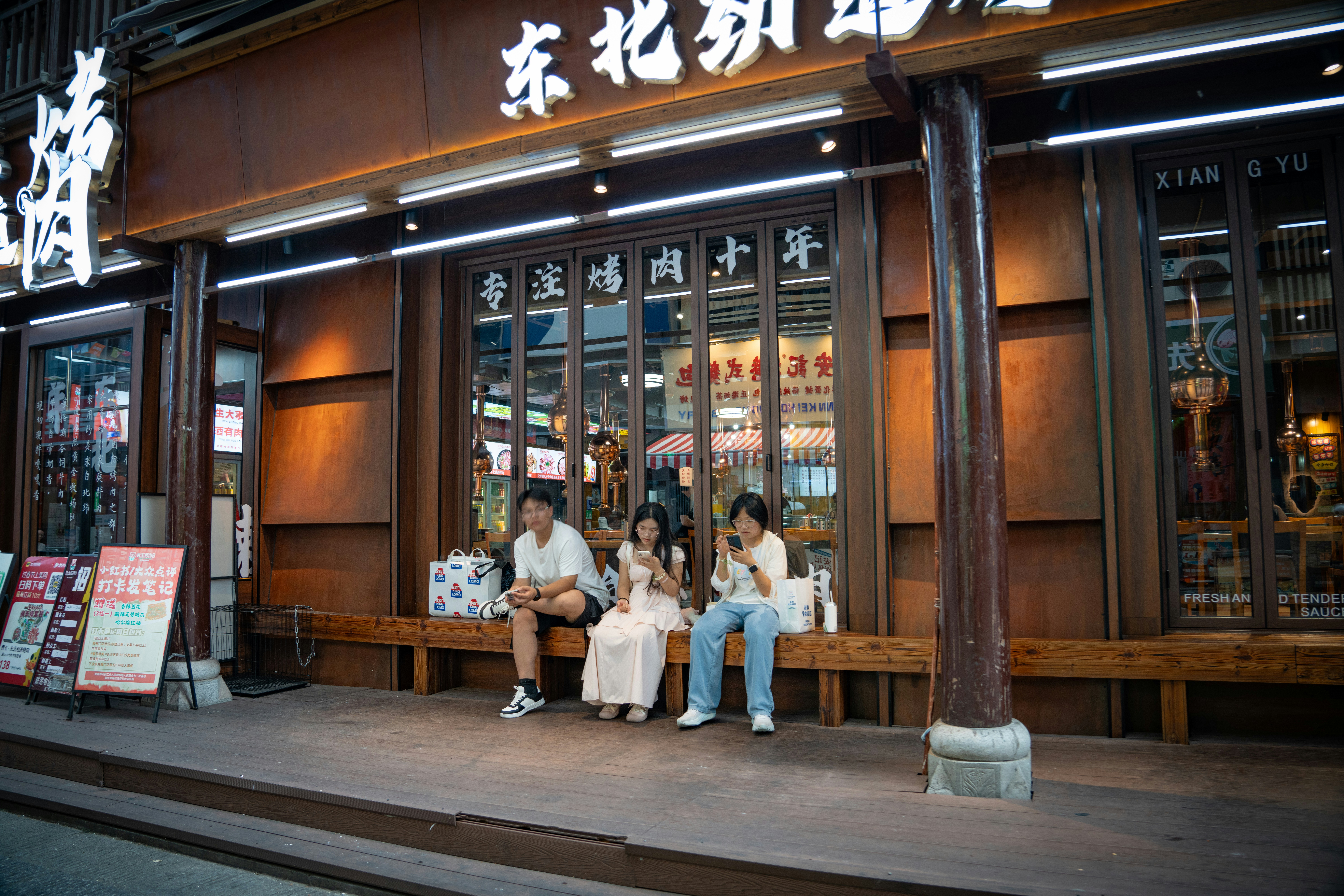 Tea House Pause: Friends Share a Quiet Moment on a Canopy of Lantern Light