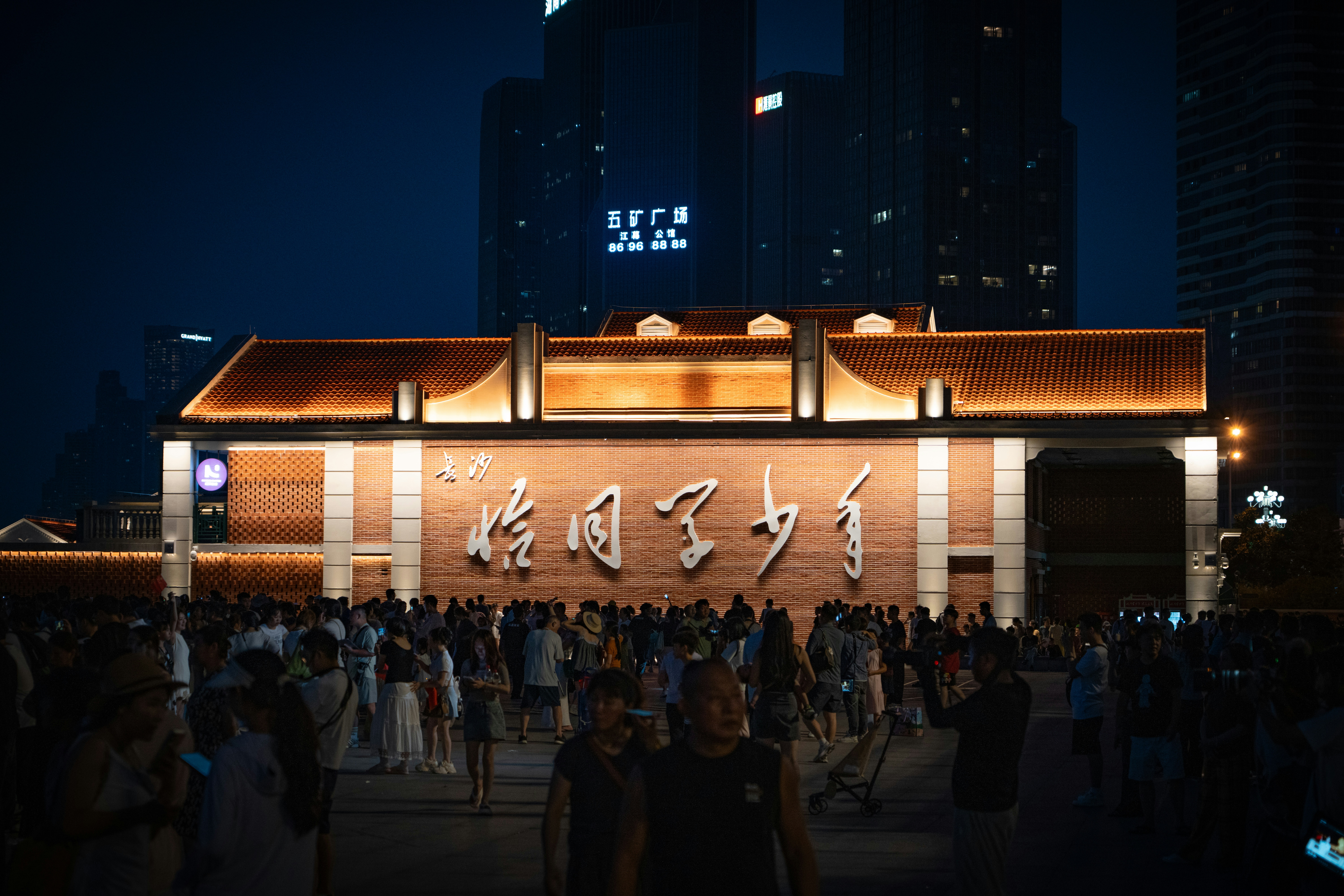 Night Gate: A Lantern-Lit Entrance Framed by a Crowded Plaza