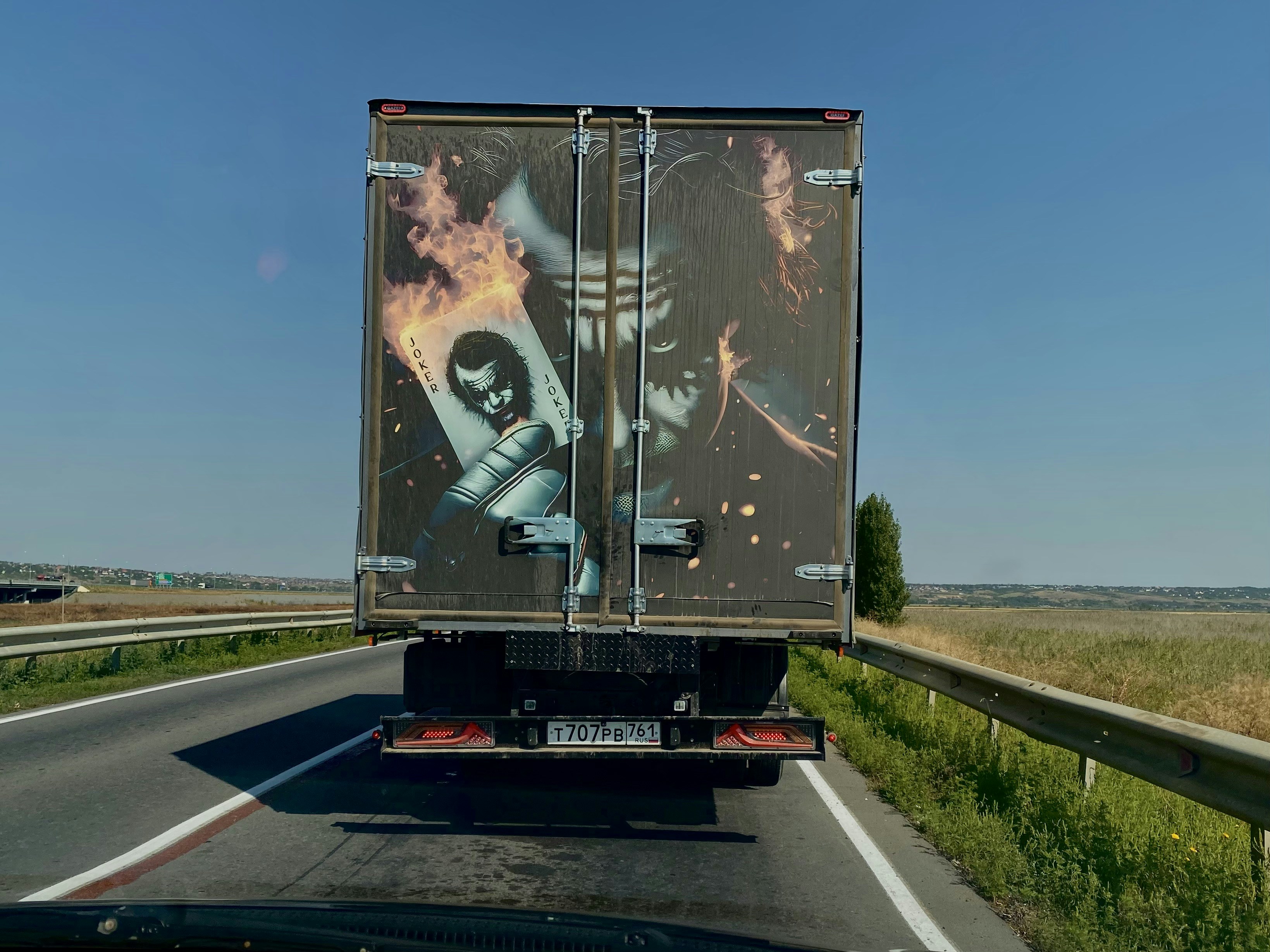 Behind the Curtain: A Truck with Graffiti Montage Drives the Open Road