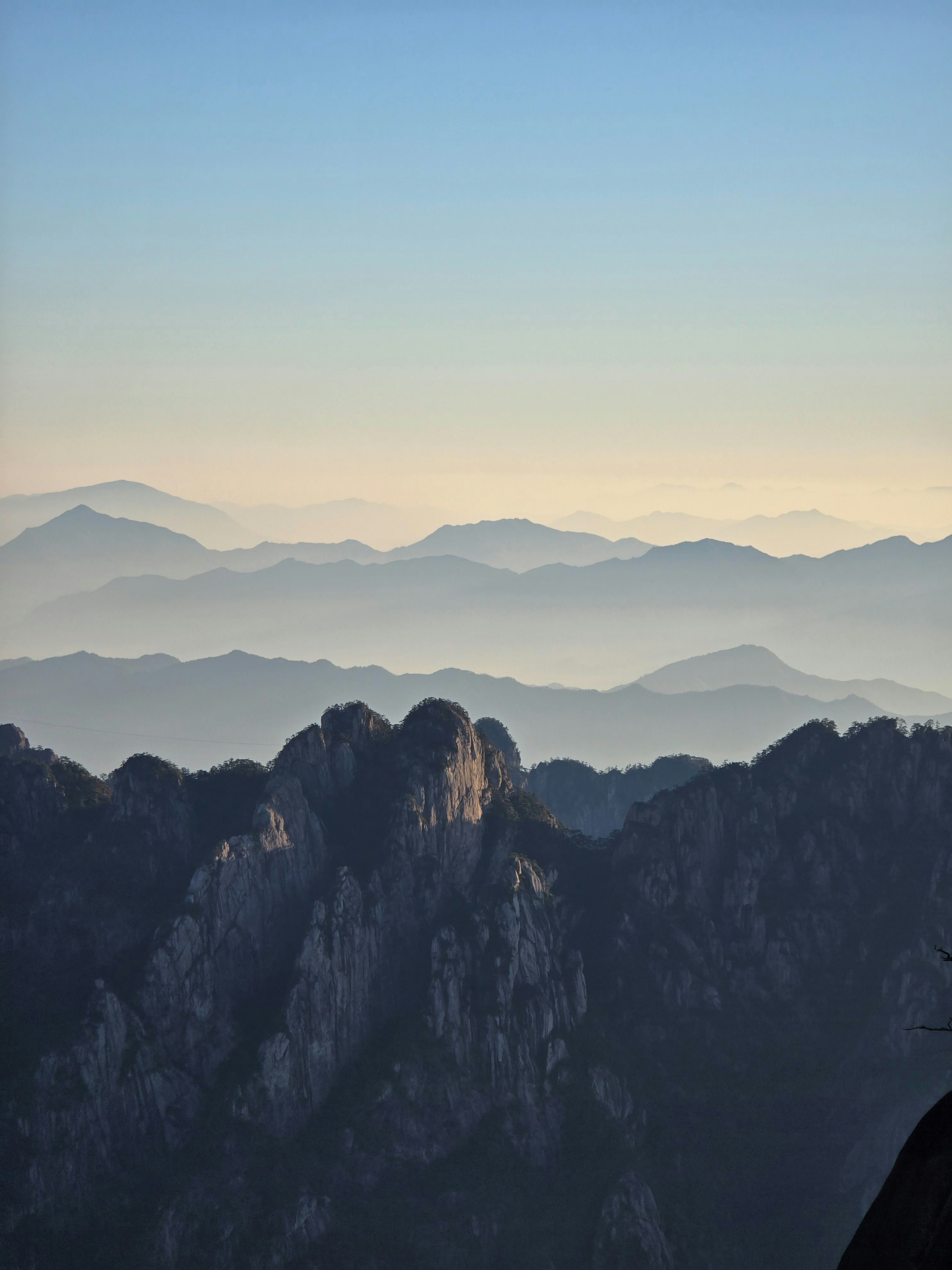 Dawn's Silhouette: Layered Peaks Beneath a Quiet Sky
