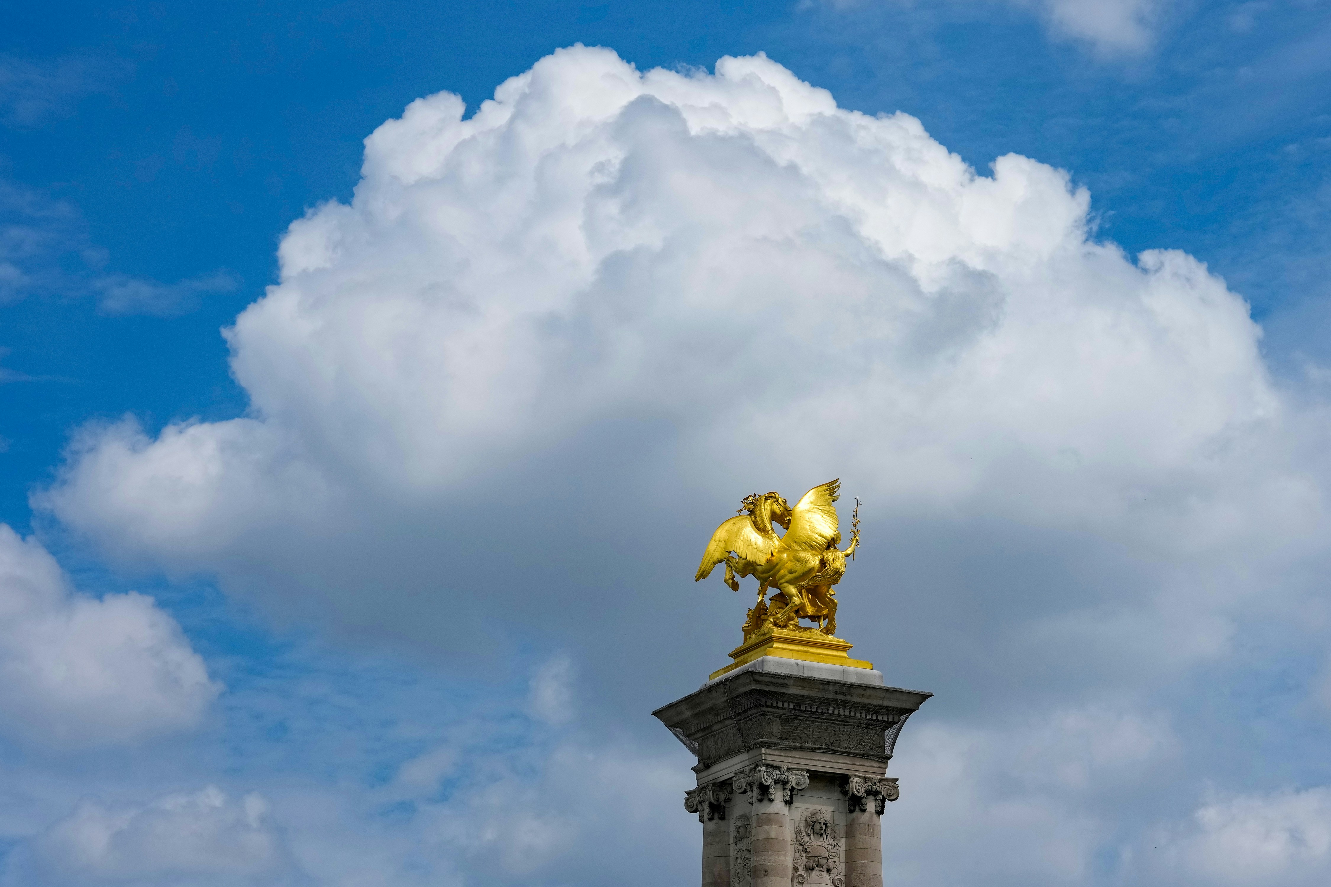 Golden Winged Sentinel: A Statue Reaching for the Sky