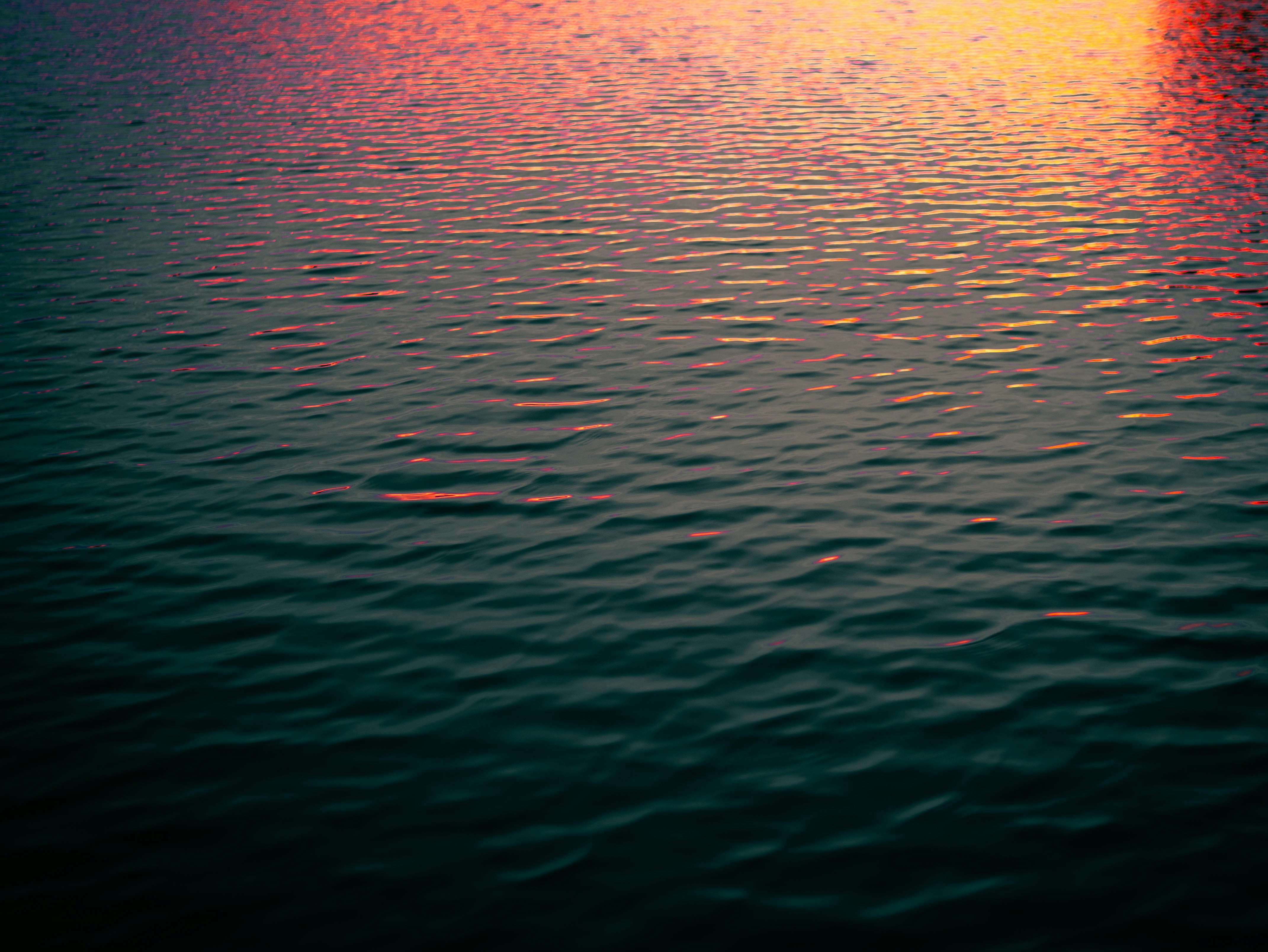 Twilight Ripples on a Quiet Teal Sea