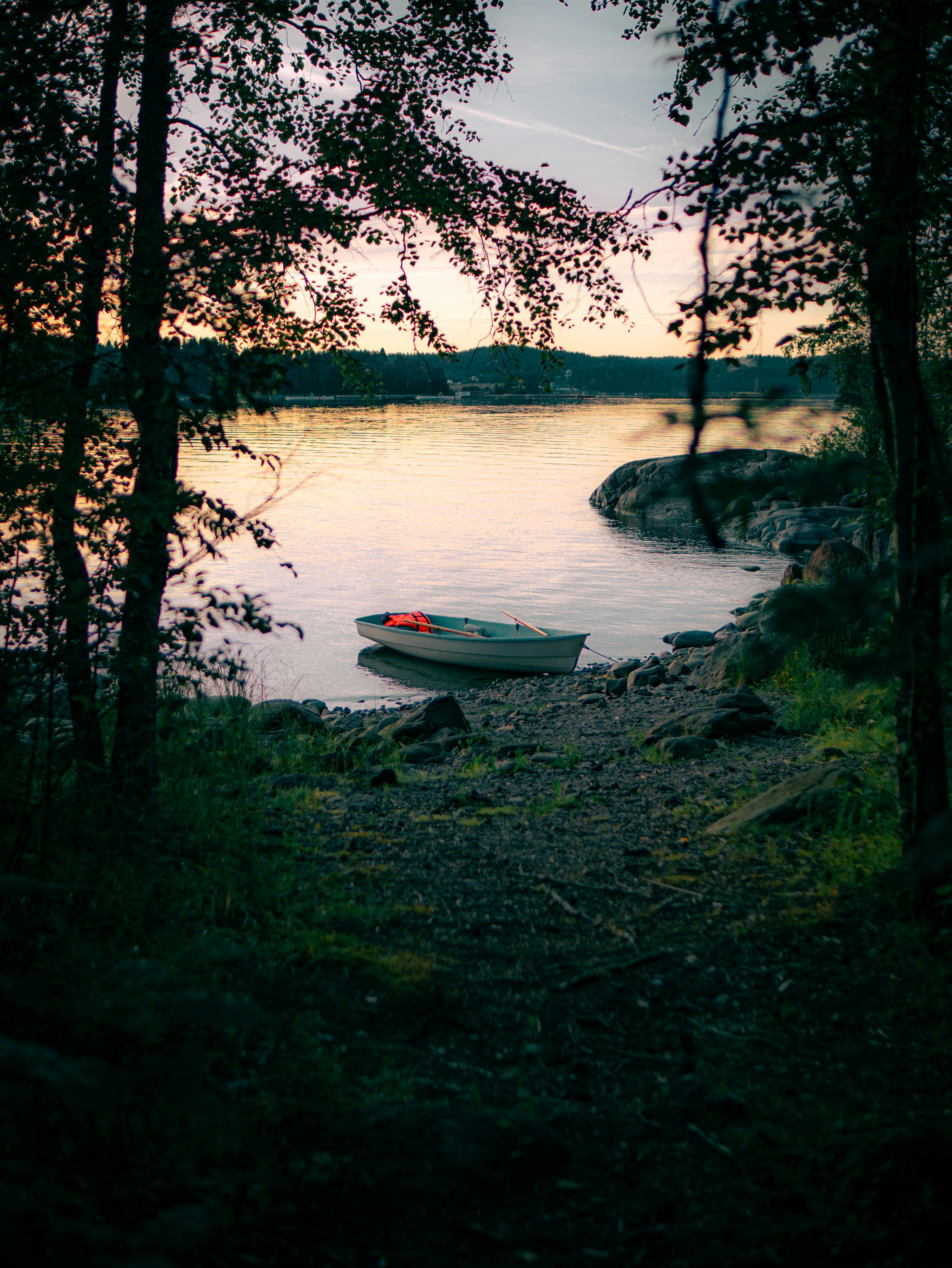 Boat at the Quiet Edge: Sunset by the Lake