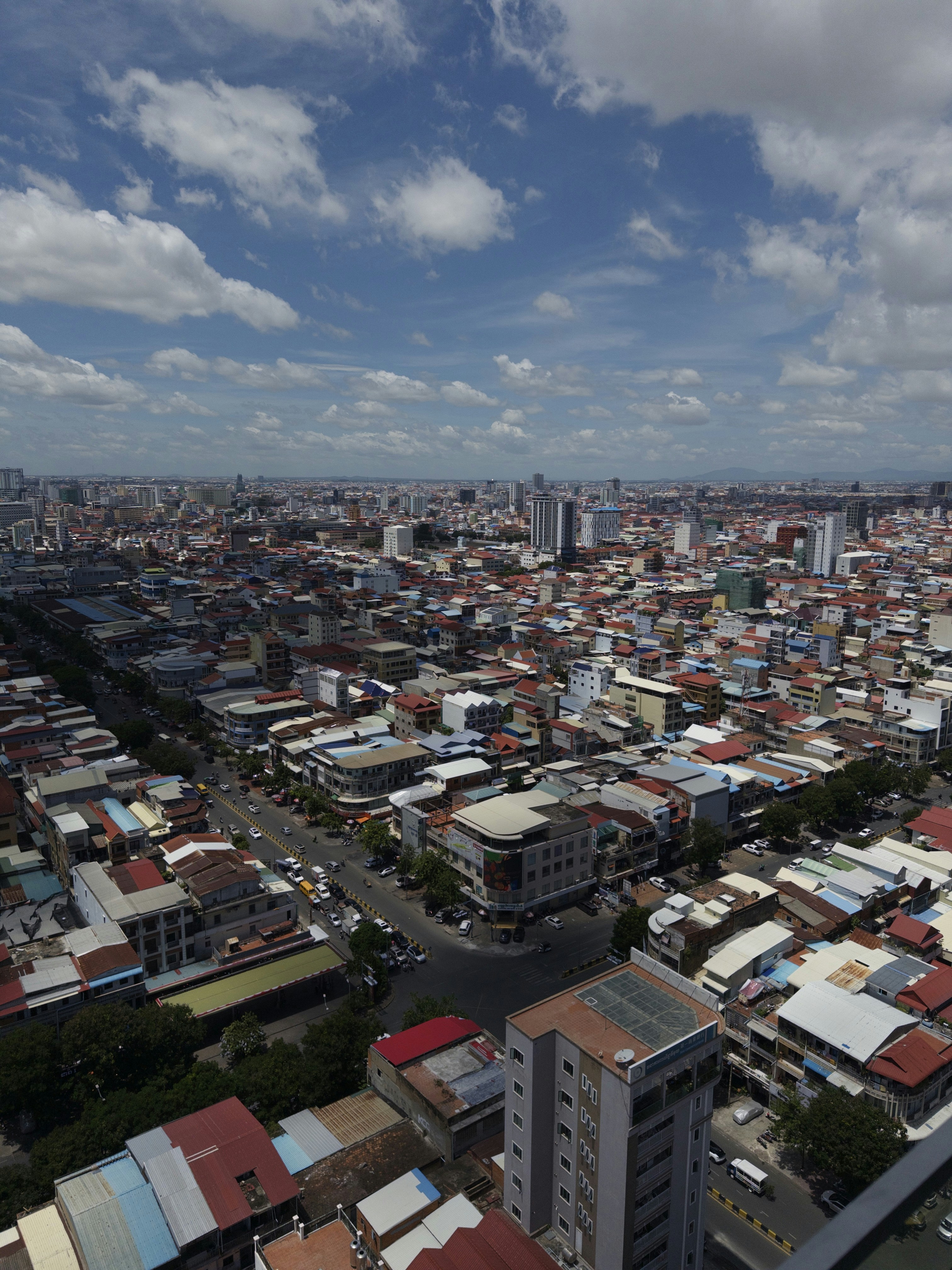 City Mosaic from Above: a woven sea of rooftops under a wide-open sky