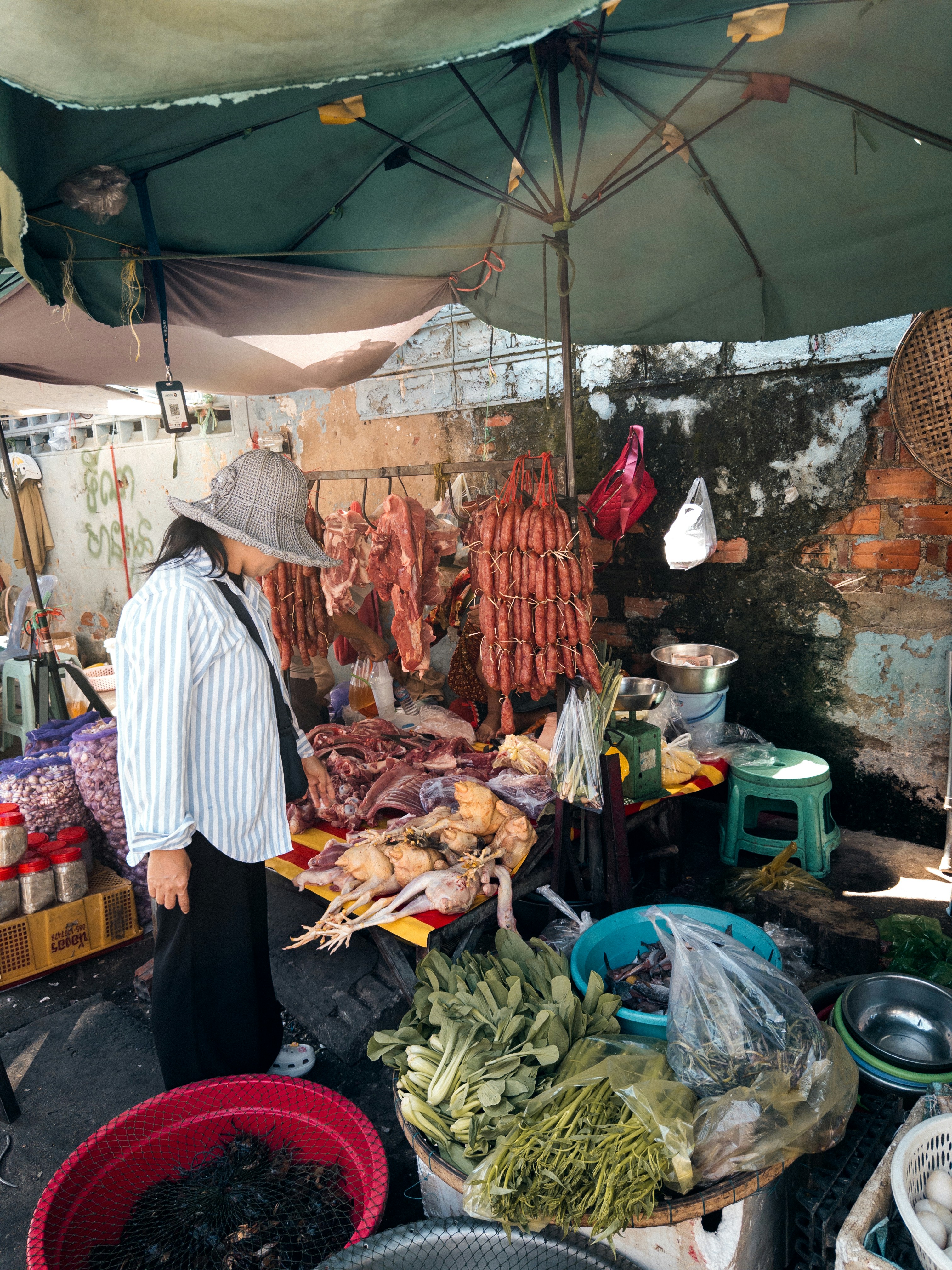 Market Butcher Under a Tarp: A Street Vendor’s Array of Fresh Cuts