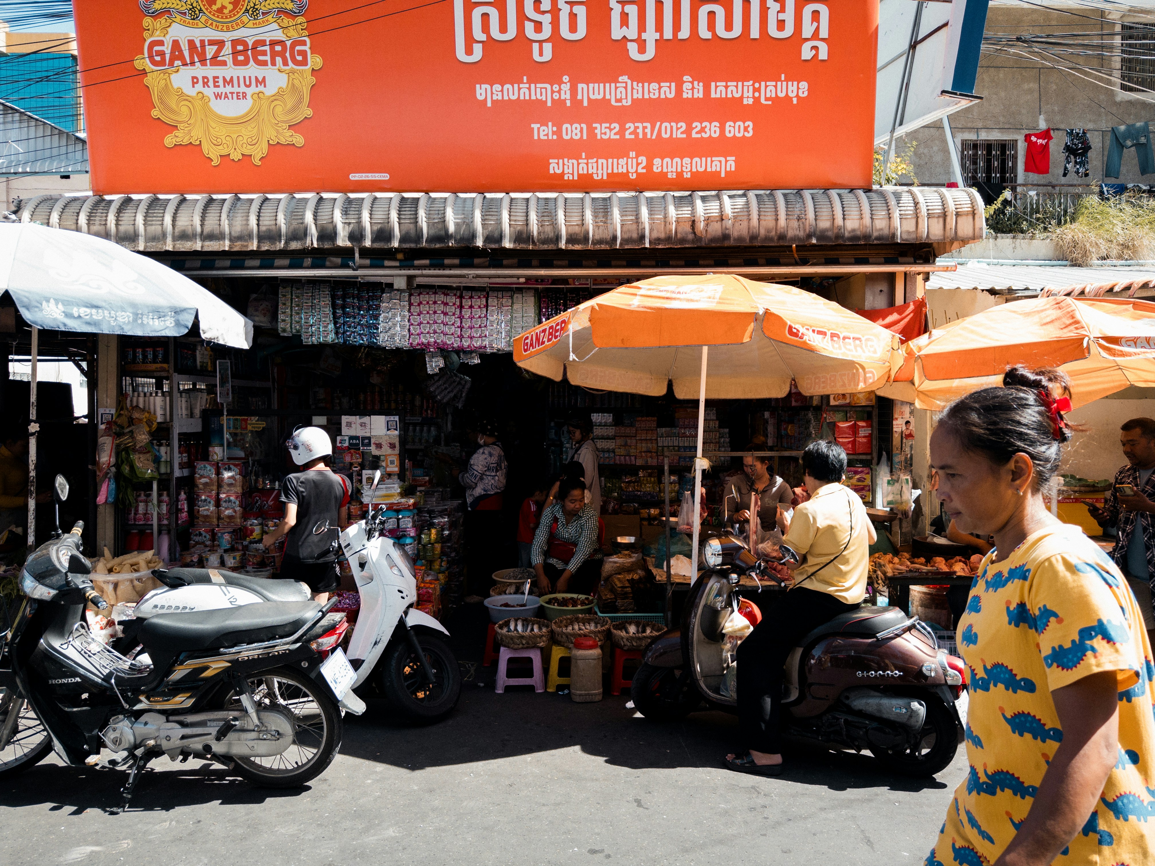 Market Pulse: Street Scene Under Orange Canopies