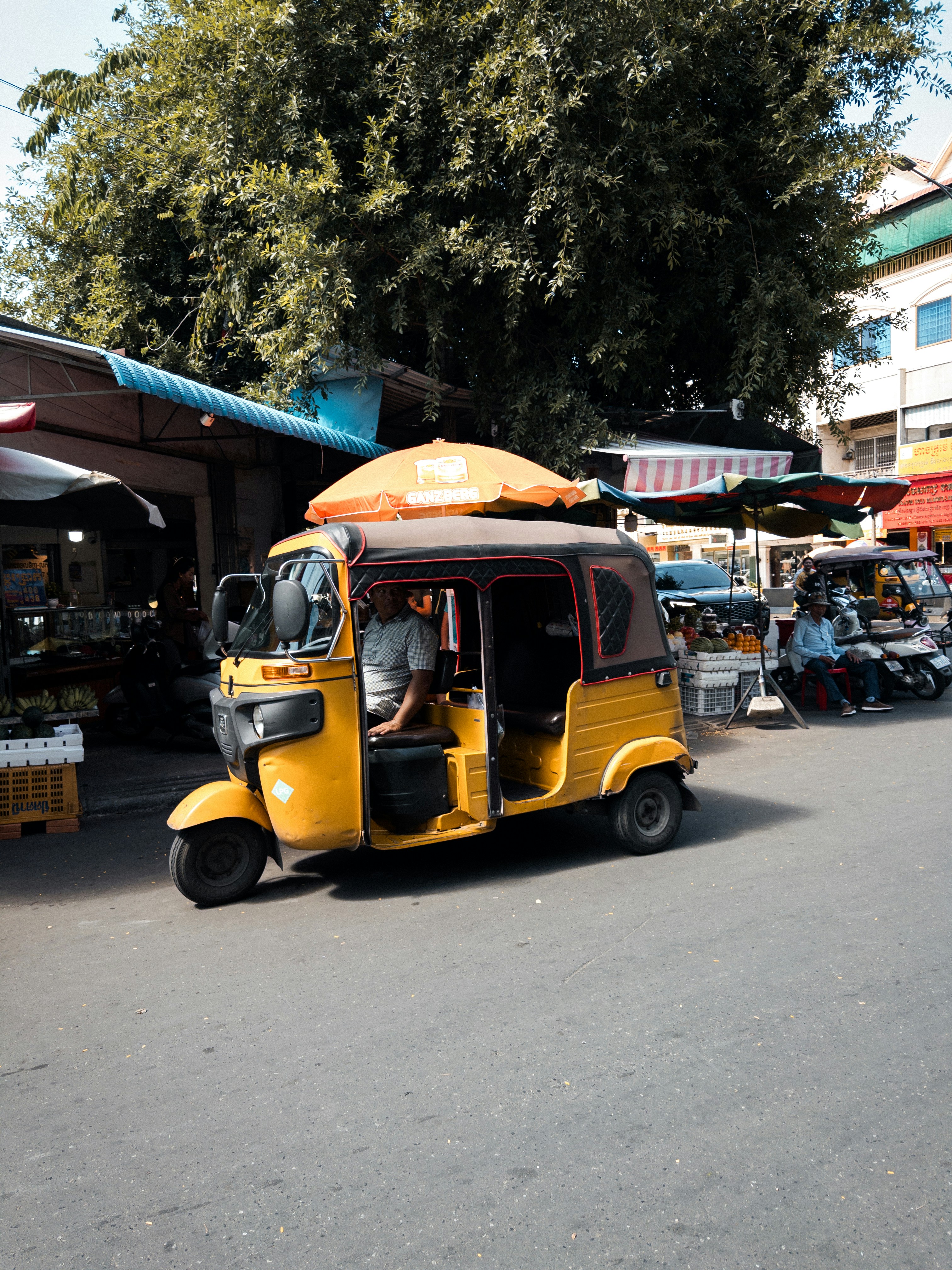 Yellow Auto Rickshaw in a Busy Market Alley