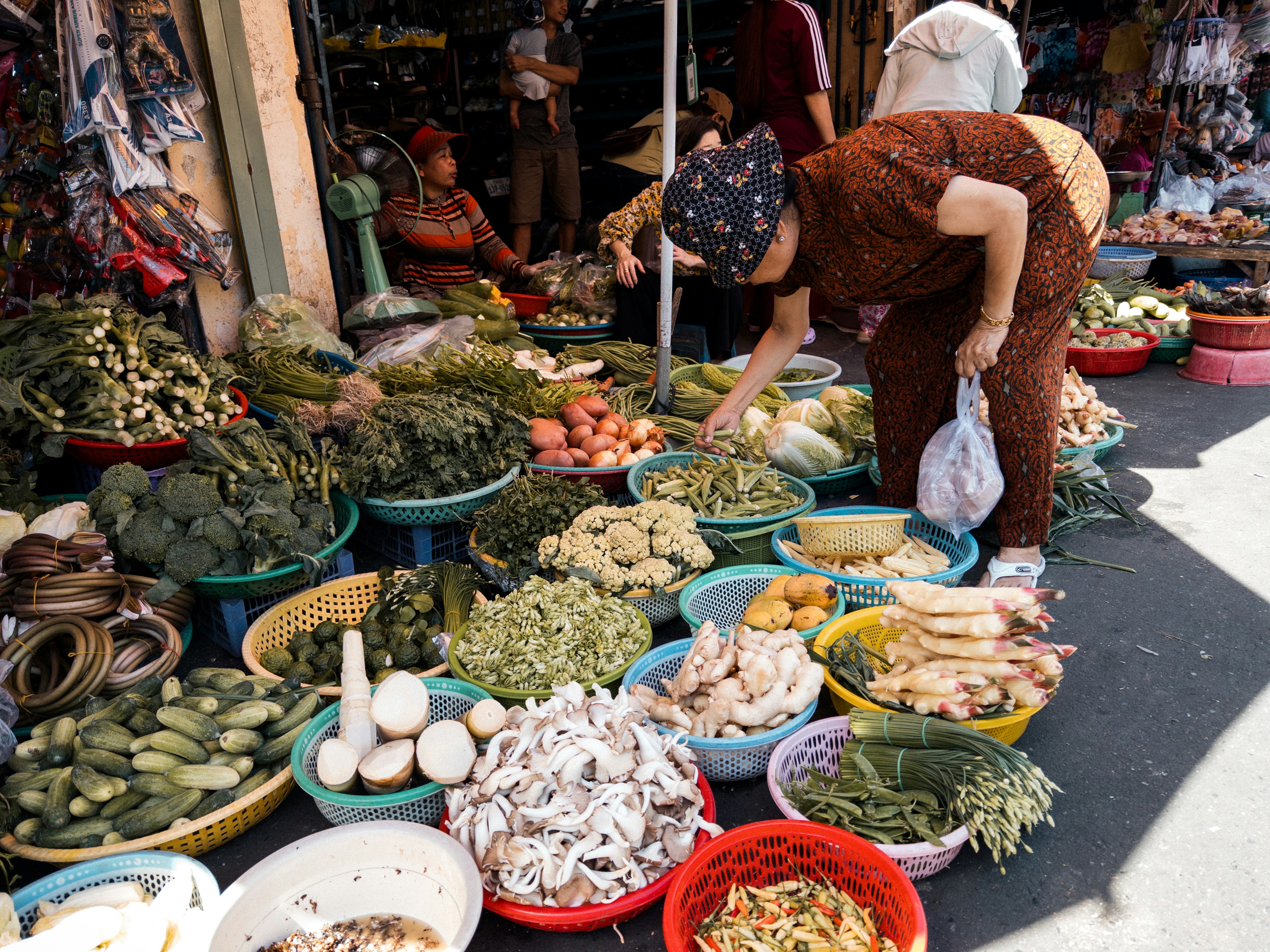 Market Vendor Cues Through a Rainbow of Fresh Produce